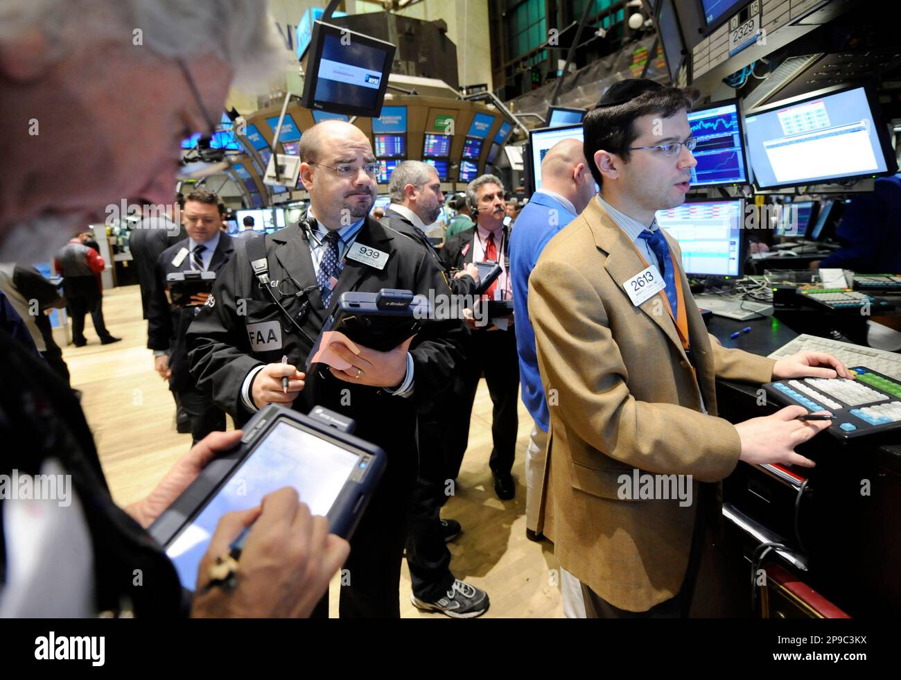Specialist Maier Tarlow, right, works at his post on the floor of the ...
