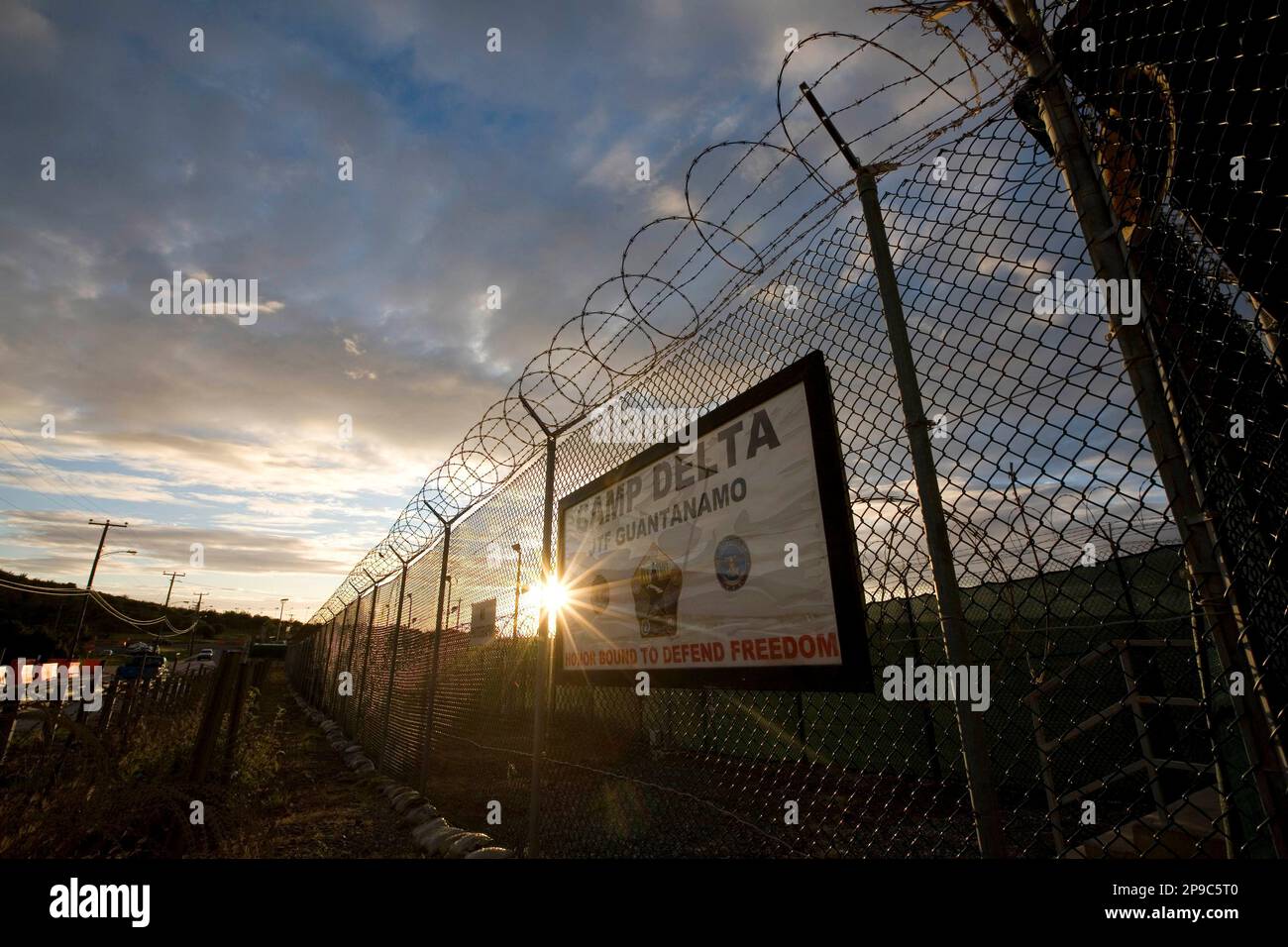 In this image reviewed by the U.S. Military, the sun rises behind a ...