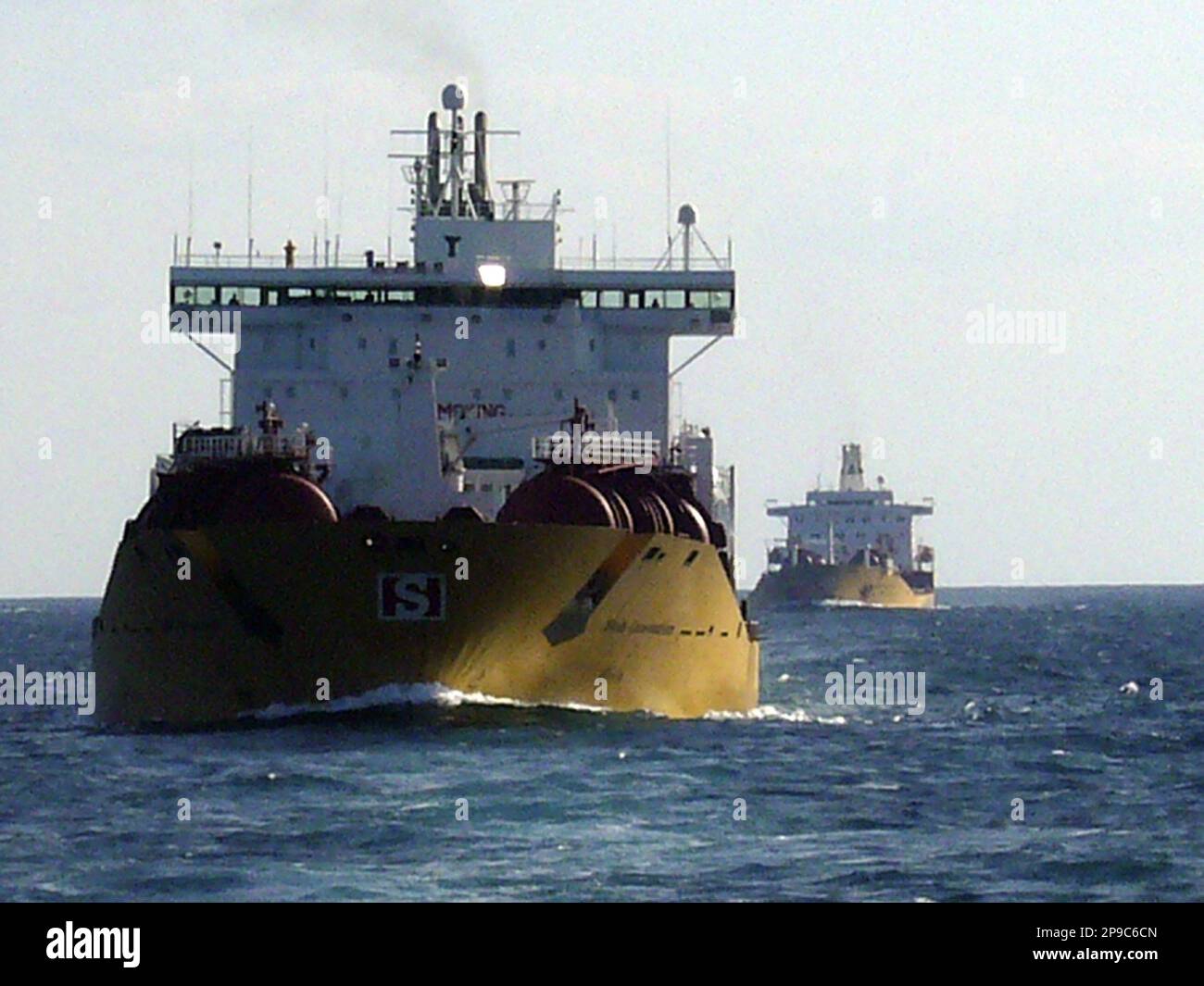 Dutch cargo ships the MV Stolt Innovation, in the foreground, and the ...