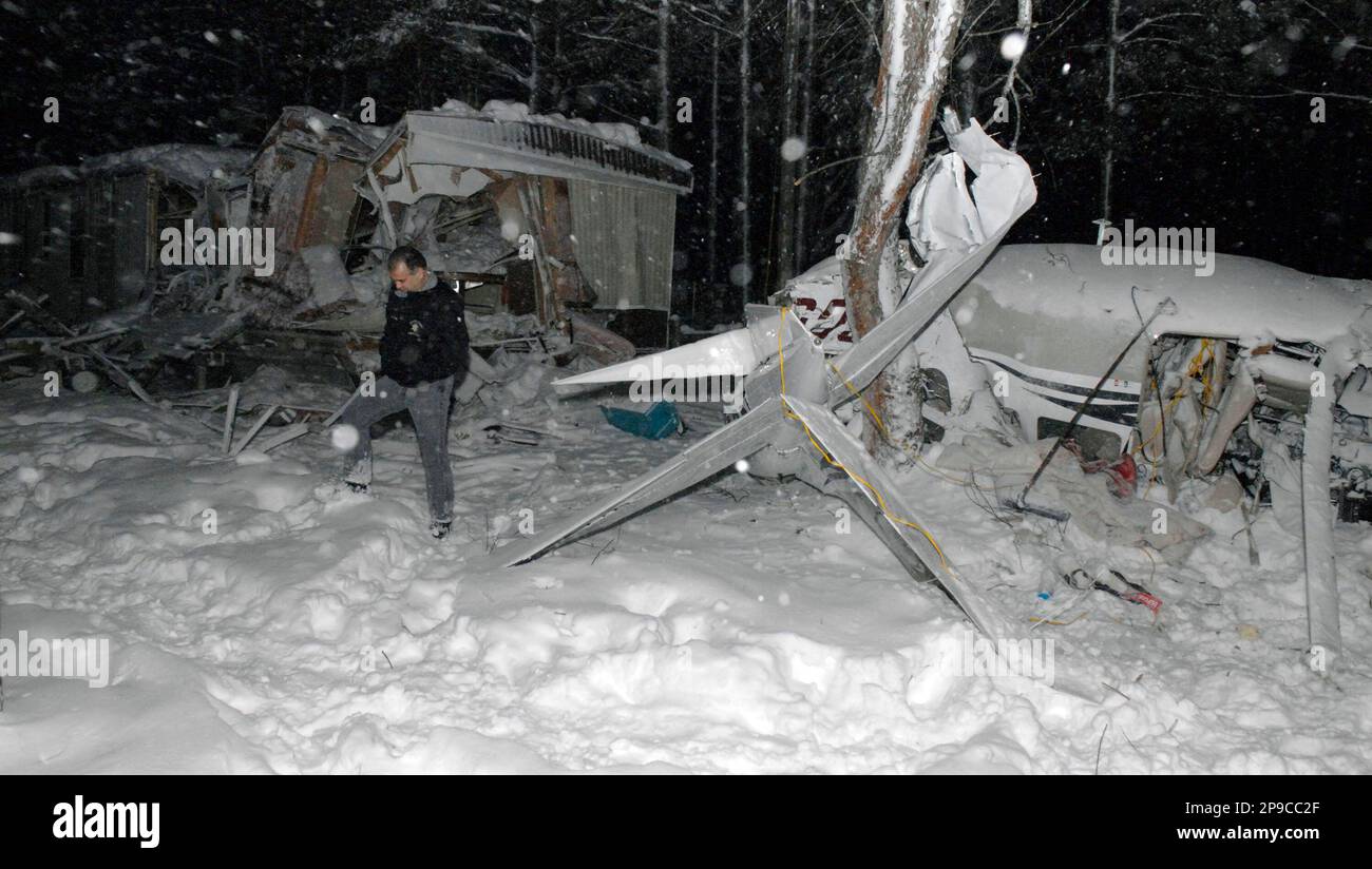 Kalkaska County Sheriff Bill Artress walks from the crash site of a ...