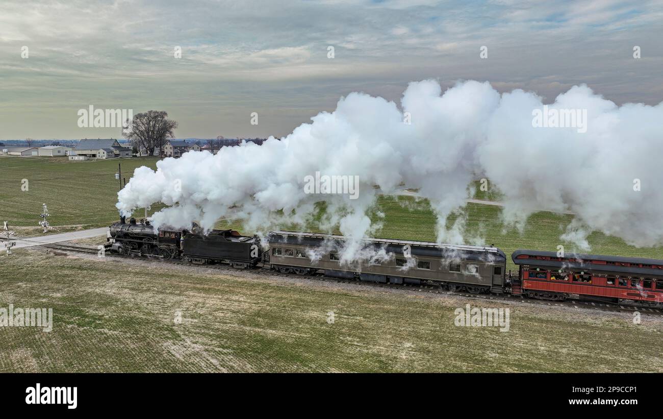 A Side Aerial View of a Steam Passenger Train Approaching, Traveling ...