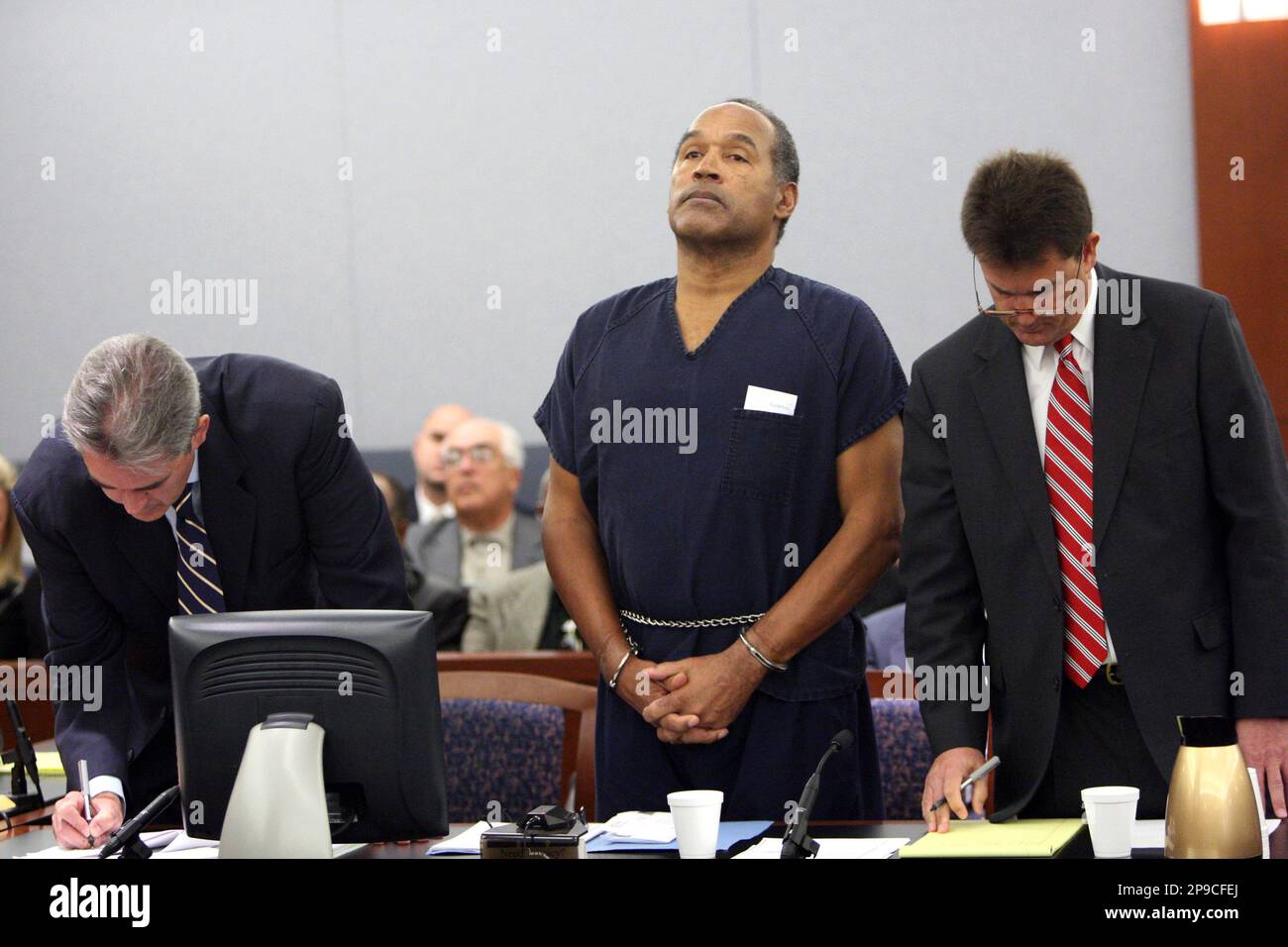 O.J. Simpson, center, listens with his attorneys Gabriel Grasso, left ...
