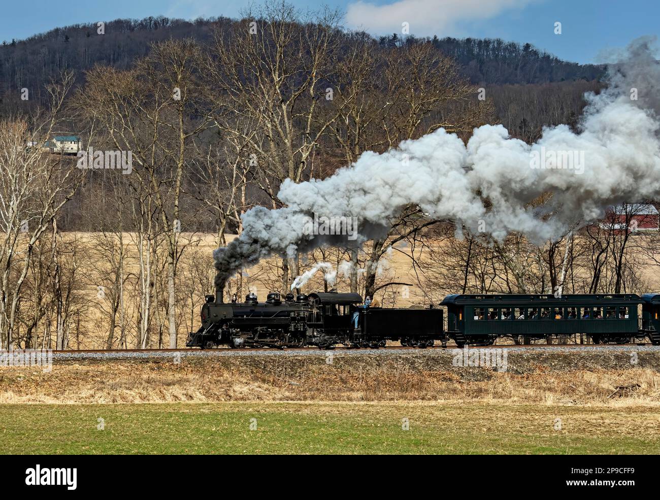 View of a Narrow Gauge Restored Steam Passenger Train Blowing Smoke and ...