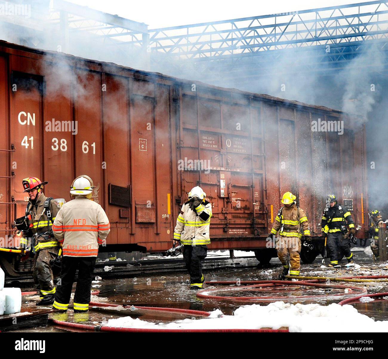 Firefighters emerge from the New England Public Warehouse as fire ...