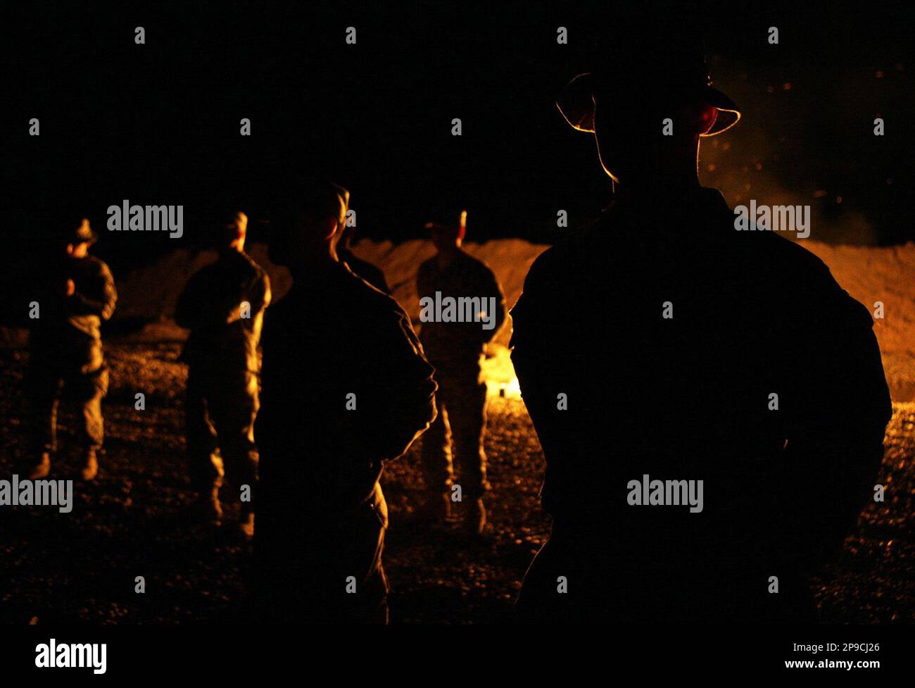 A bonfire illuminates U.S. Army soldiers from Bravo Company, 1st ...