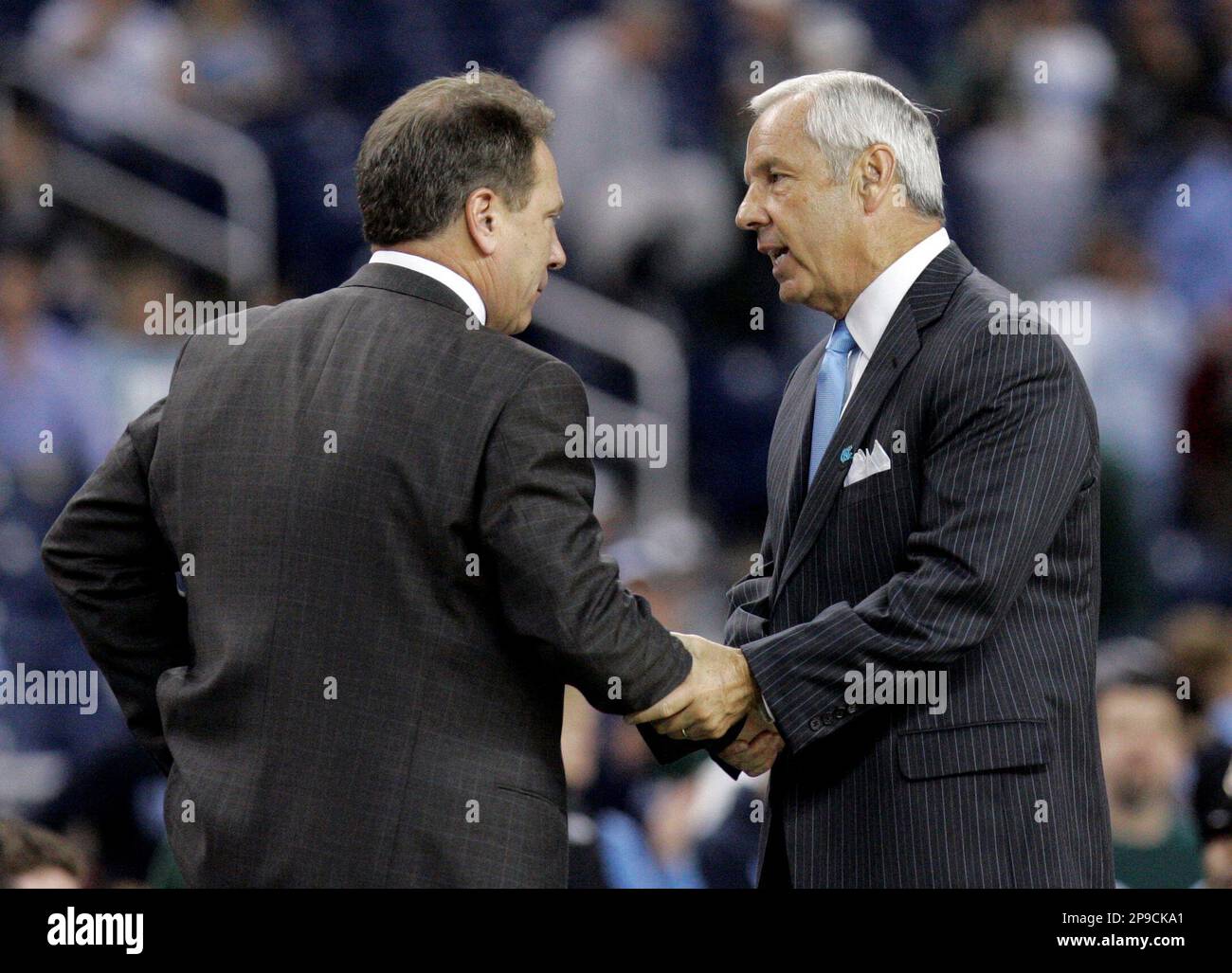 North Carolina coach Roy Williams, right, shakes hands with Michigan ...