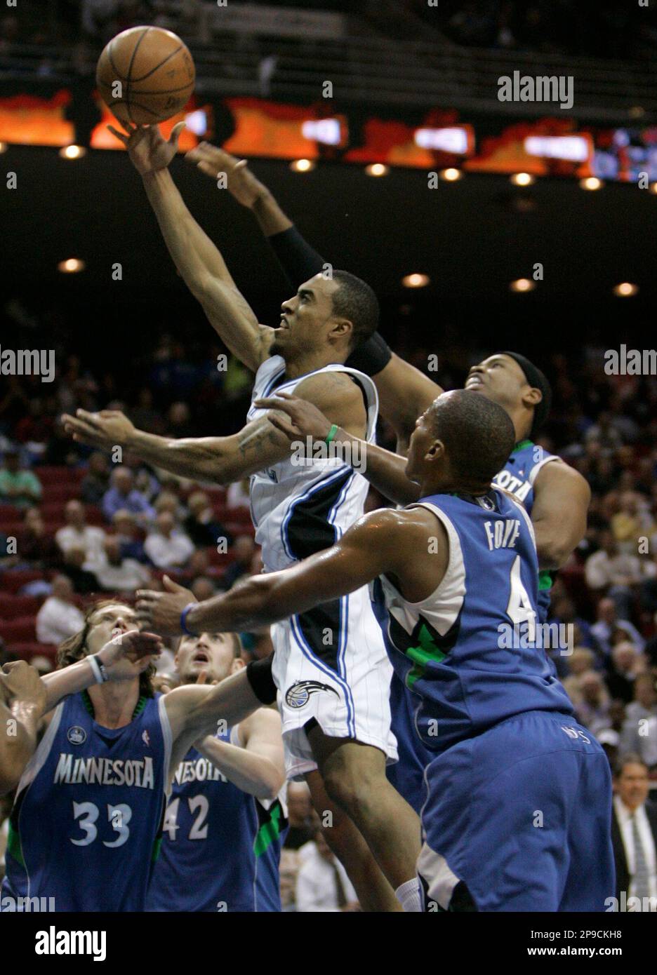 Orlando Magic guard Courtney Lee, center, drives between Minnesota ...