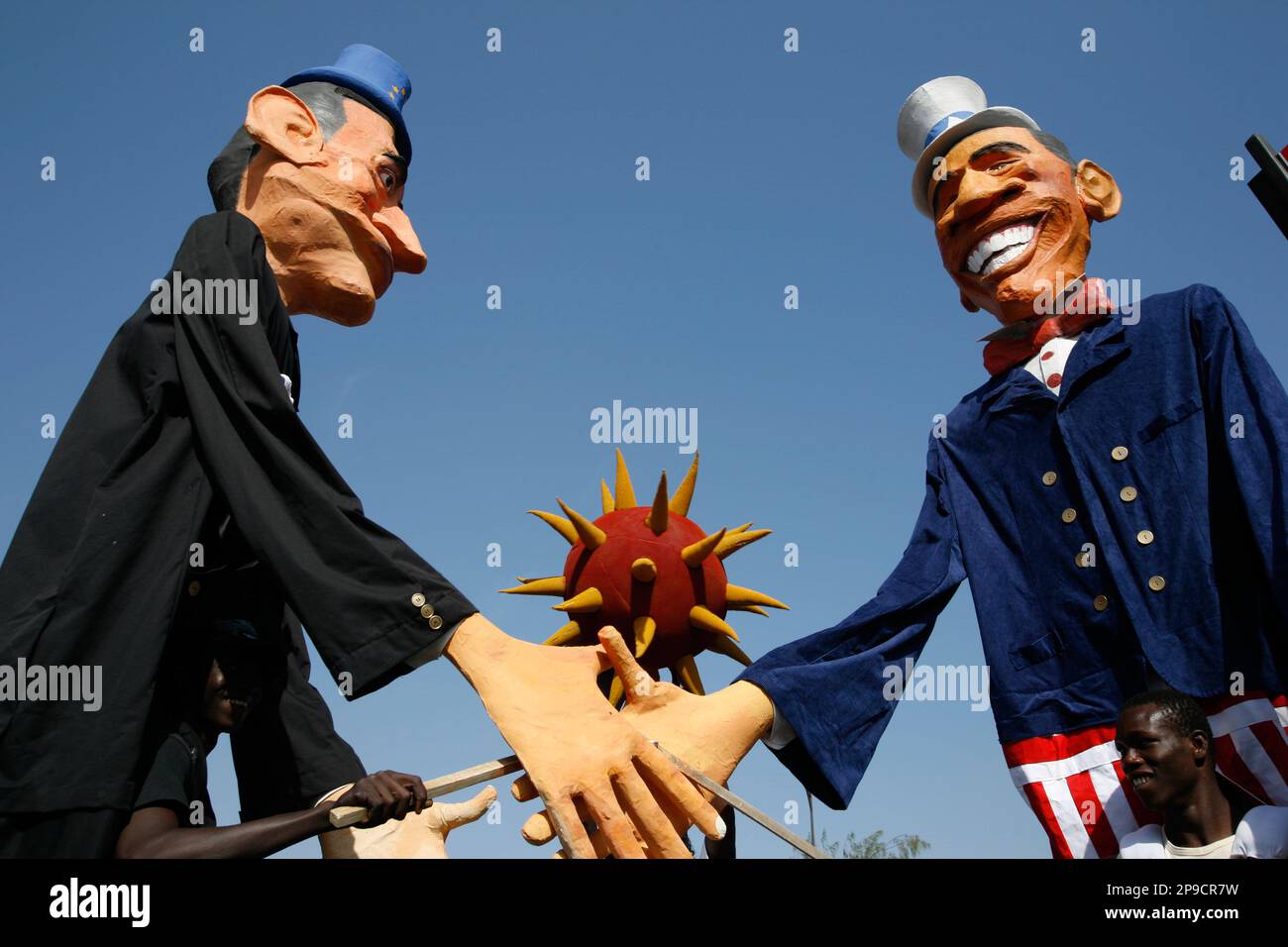Giant puppets representing French President Nicolas Sarkozy, left, and ...