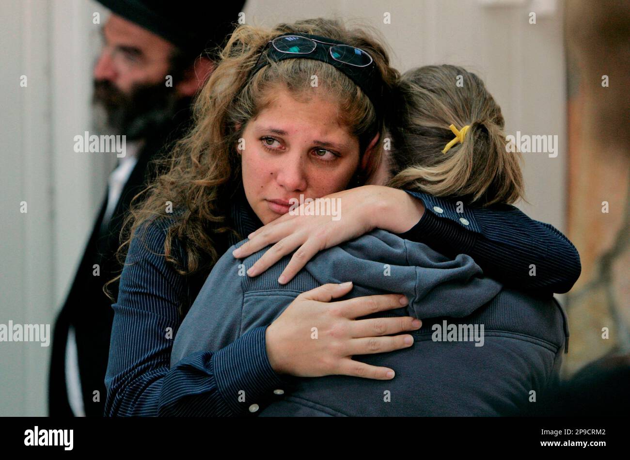 Jean Goldie Horta Rabinovich, left, is comforted by her sister Orli ...