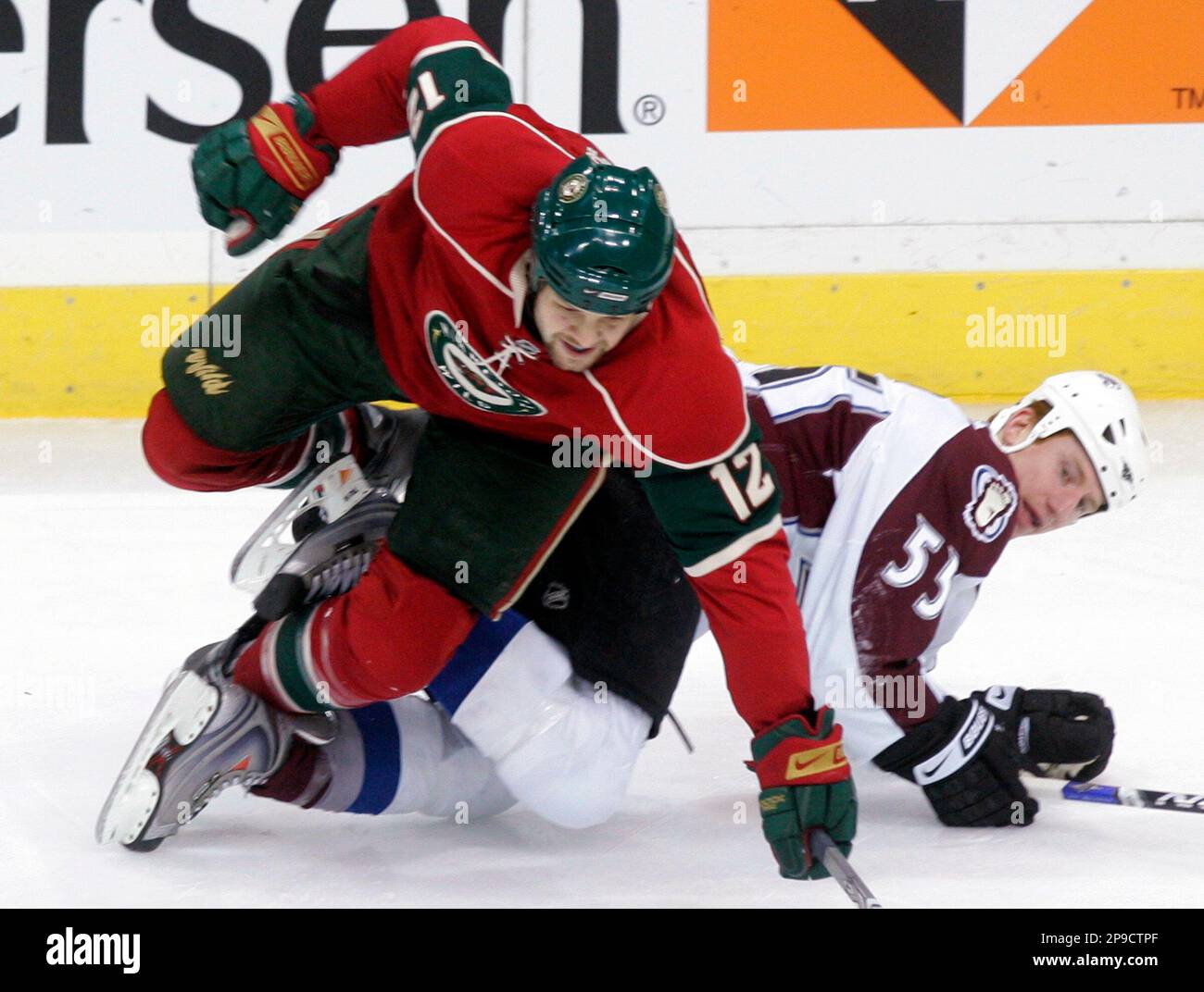 Minnesota Wild's Craig Weller, left, trips over Colorado Avalanche's ...