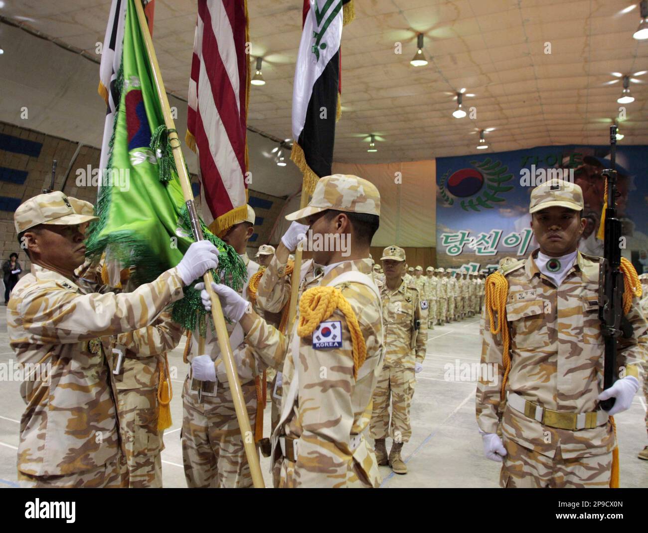 South Korean soldiers carry flags during a ceremony to mark the end of ...