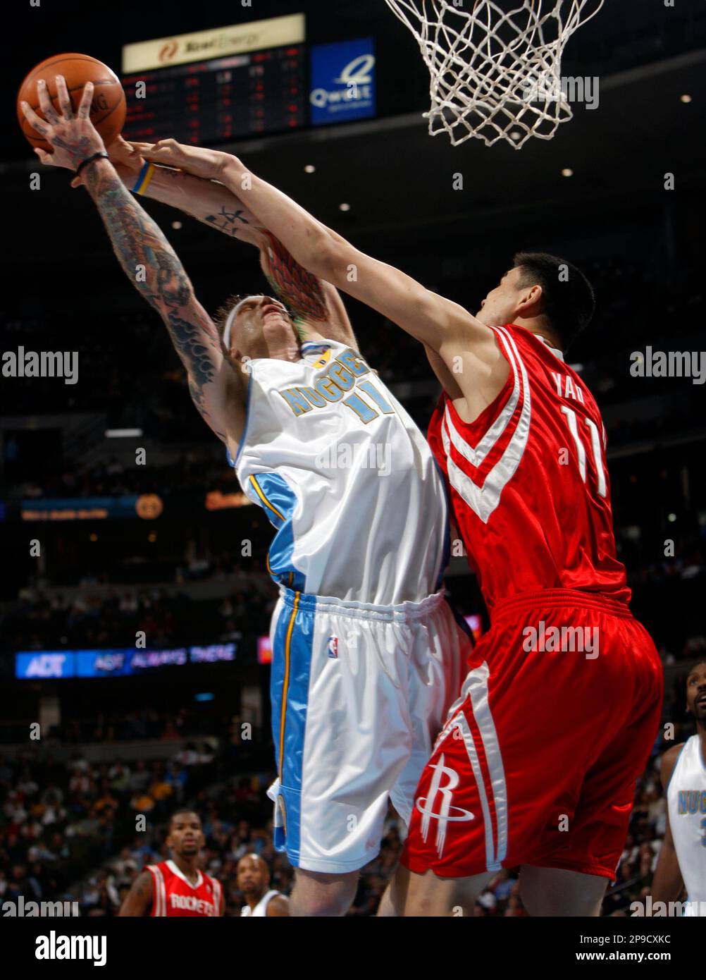 Denver Nuggets forward Chris Andersen, left, has his shot blocked by Houston Rockets center Yao ...