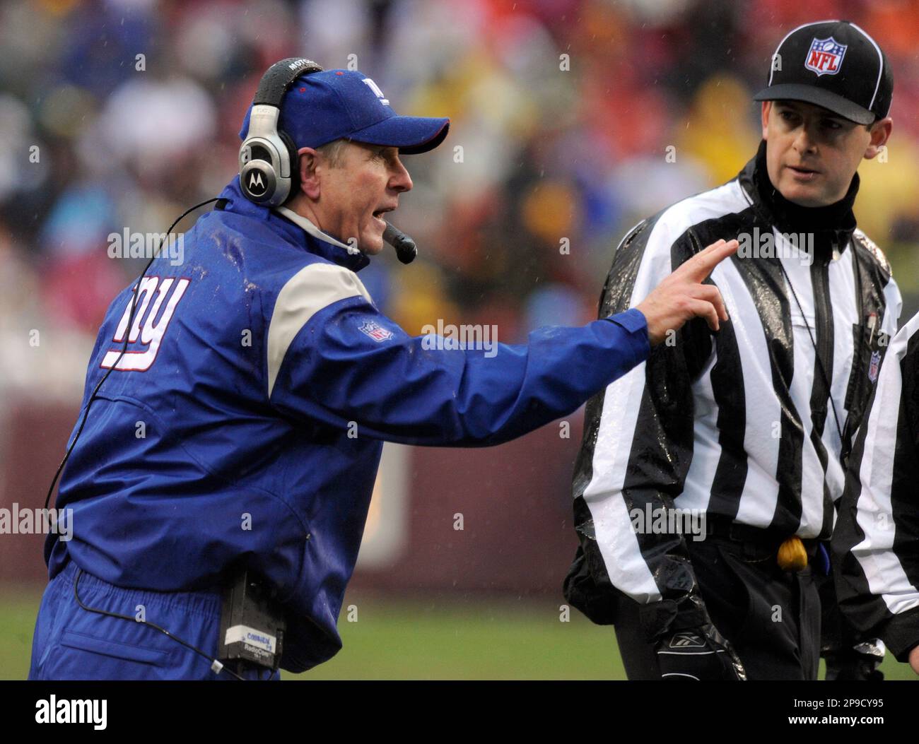 New York Giants coach Tom Coughlin, left, talks with officials during ...