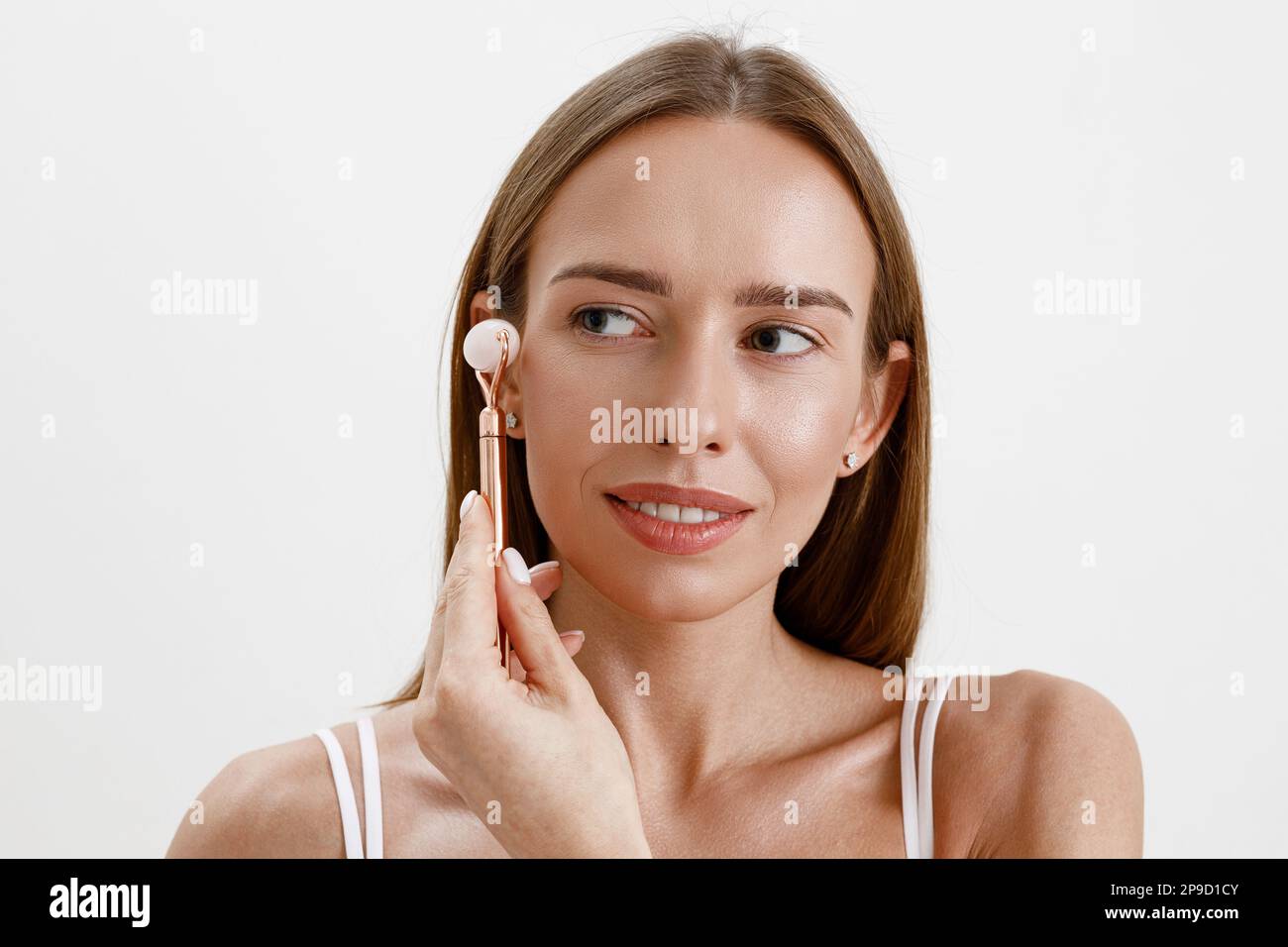 Woman Doing Massage With Stone Facial Roller On White Background