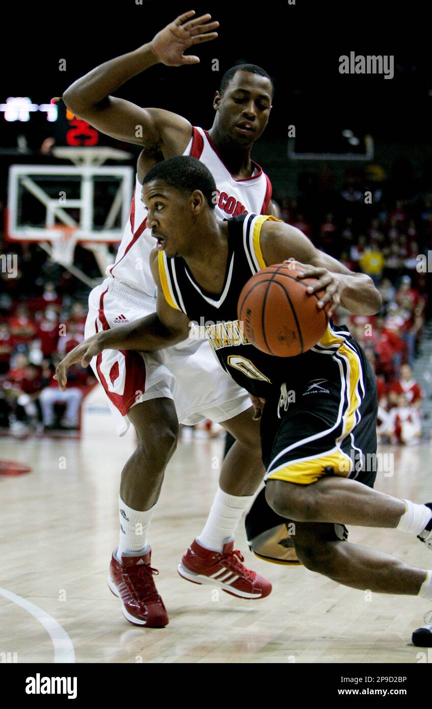 Wisconsin-Milwaukee Avery Smith drives around Wisconsin's Trevon Hughes ...