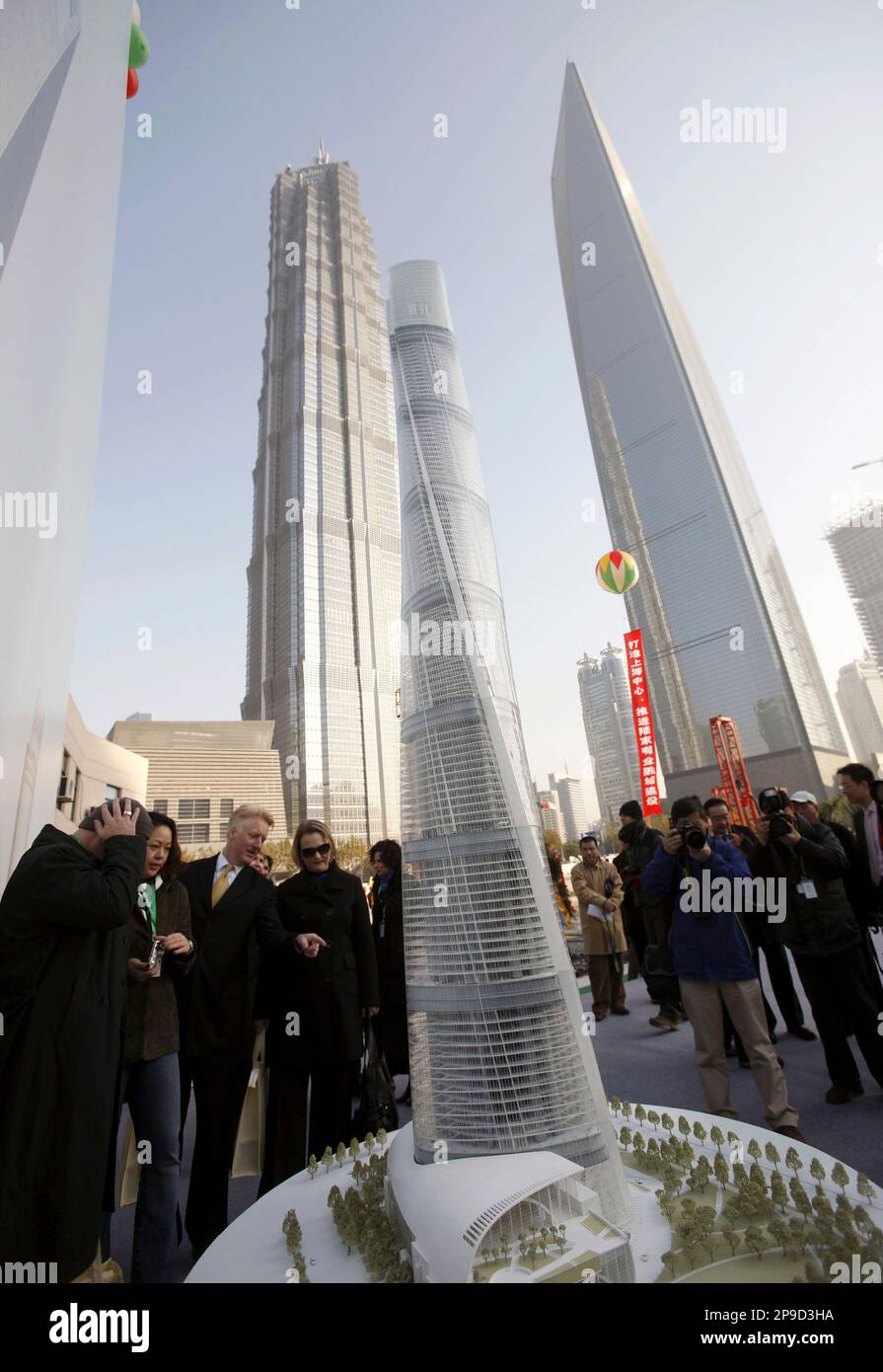 People look at a scale model of the Shanghai Tower at its ...