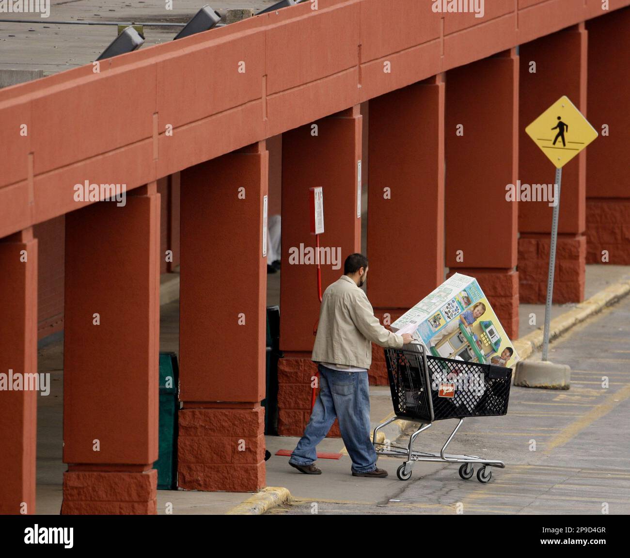 A shopper leaves a Sears Grand store with his packages Friday, Nov. 28 ...