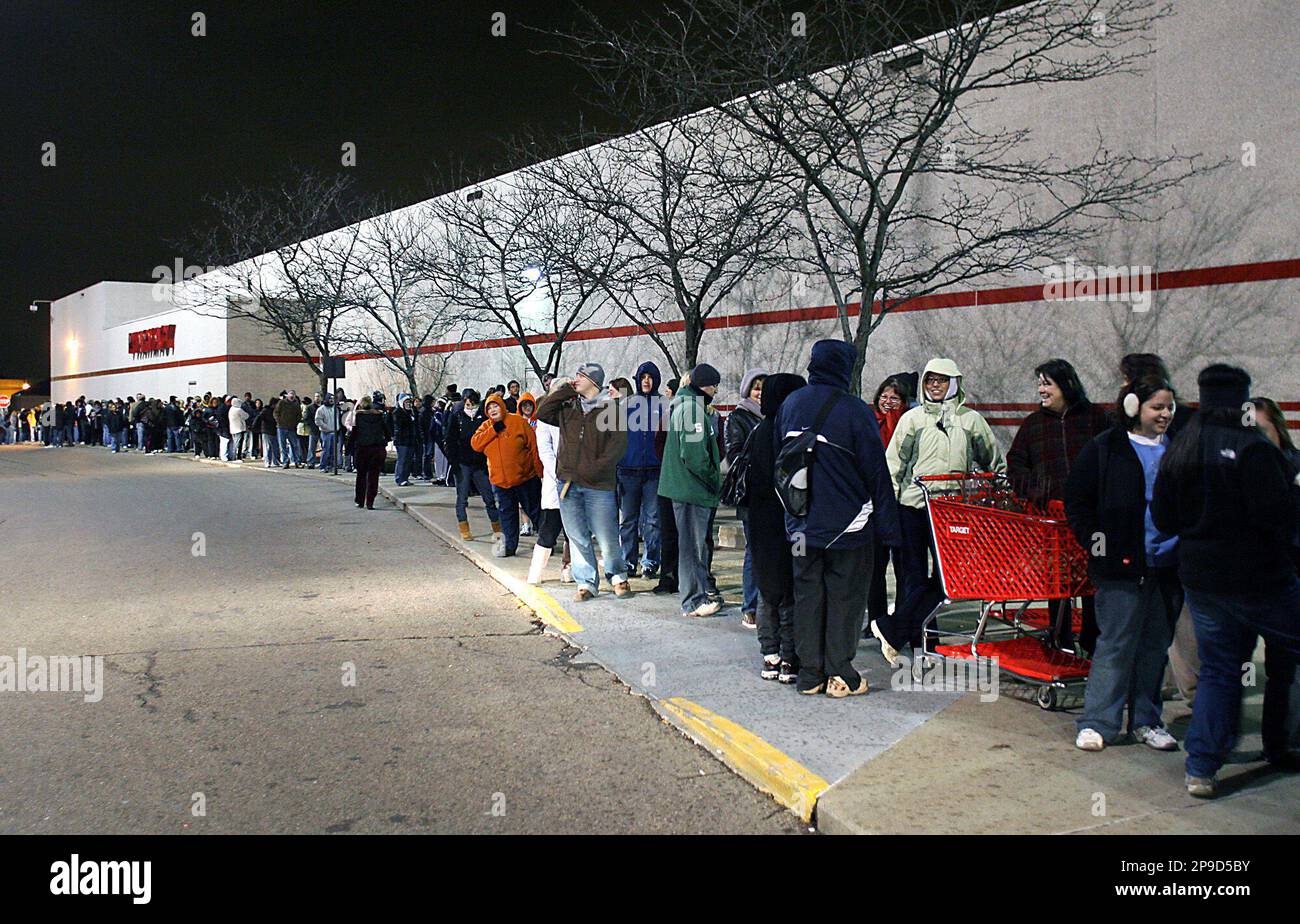 A line snakes around a Target store in Madison Heights, Mich. as ...