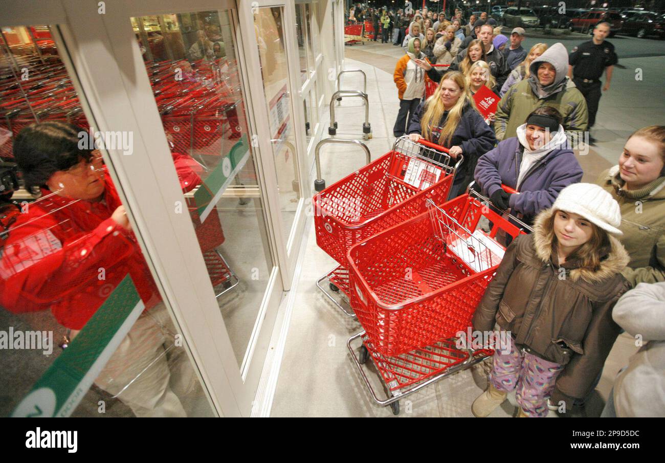 A long line of shoppers wait for the 6 a.m. opening of the Target store ...
