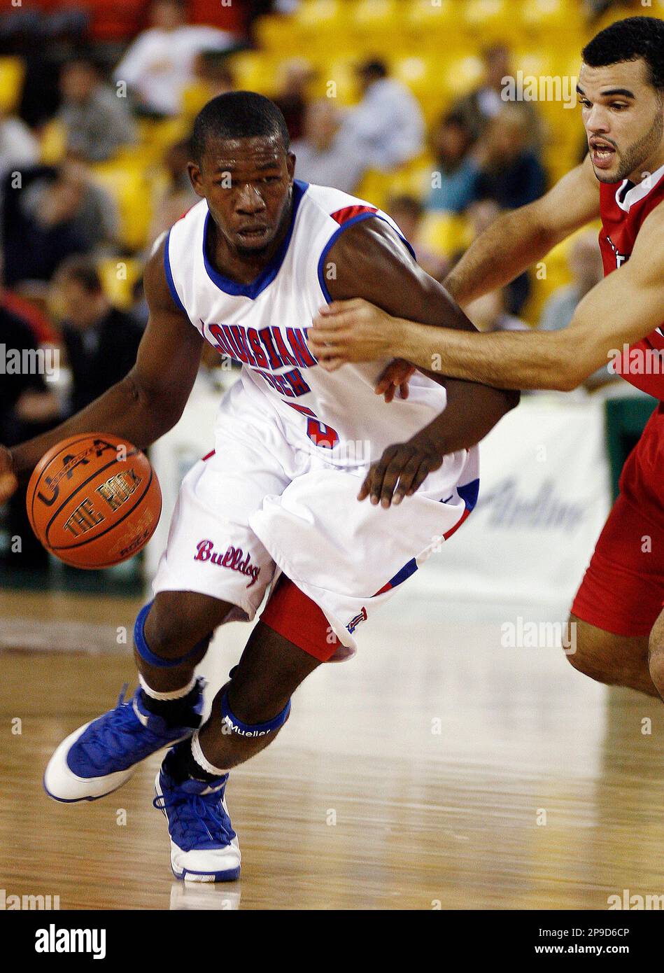 Louisiana Tech's Olu Ashaolu drives past Seattle's Mike Boxley during a ...