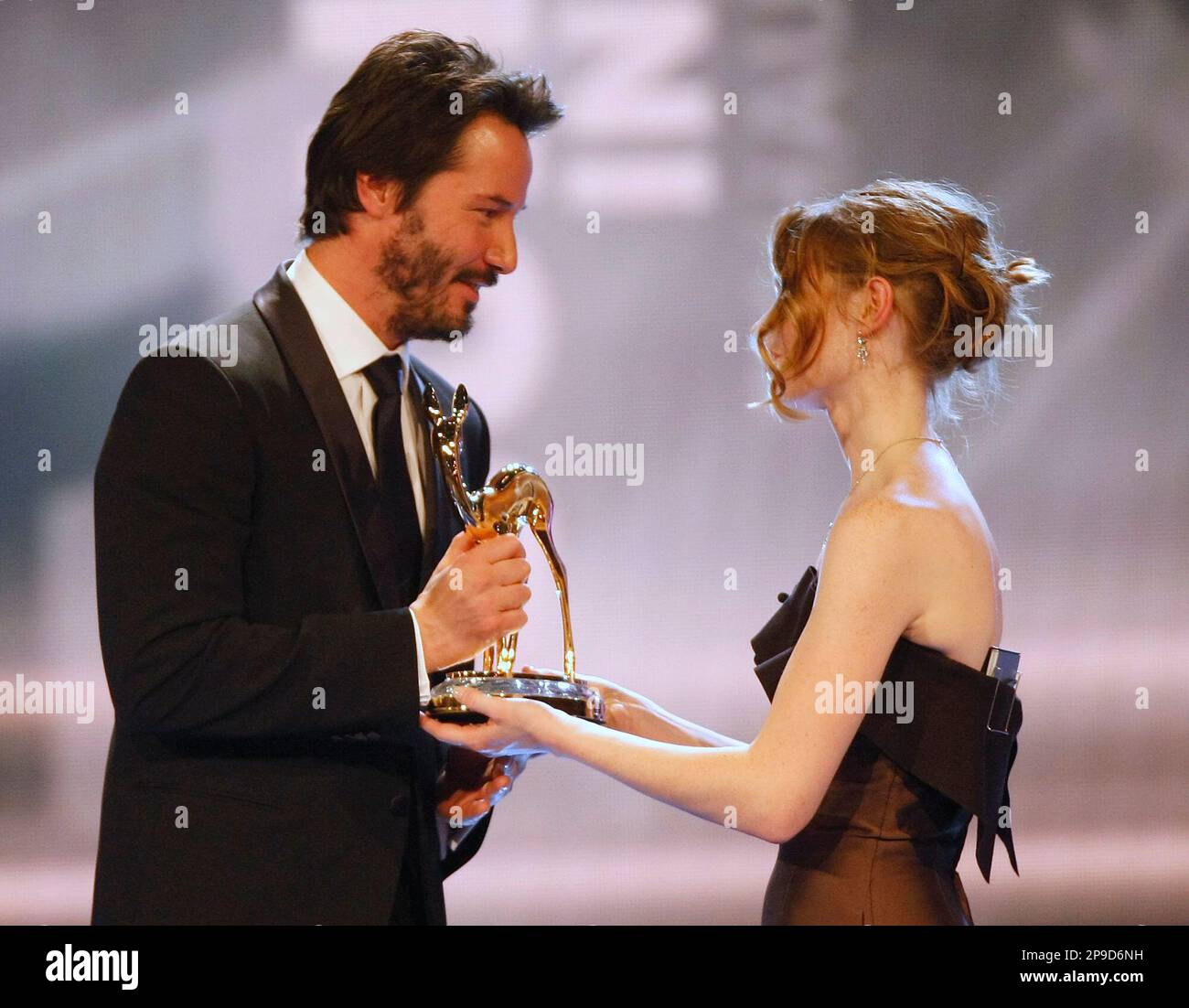 US actor Keanu Reeves, left, receives the prize from German actress ...