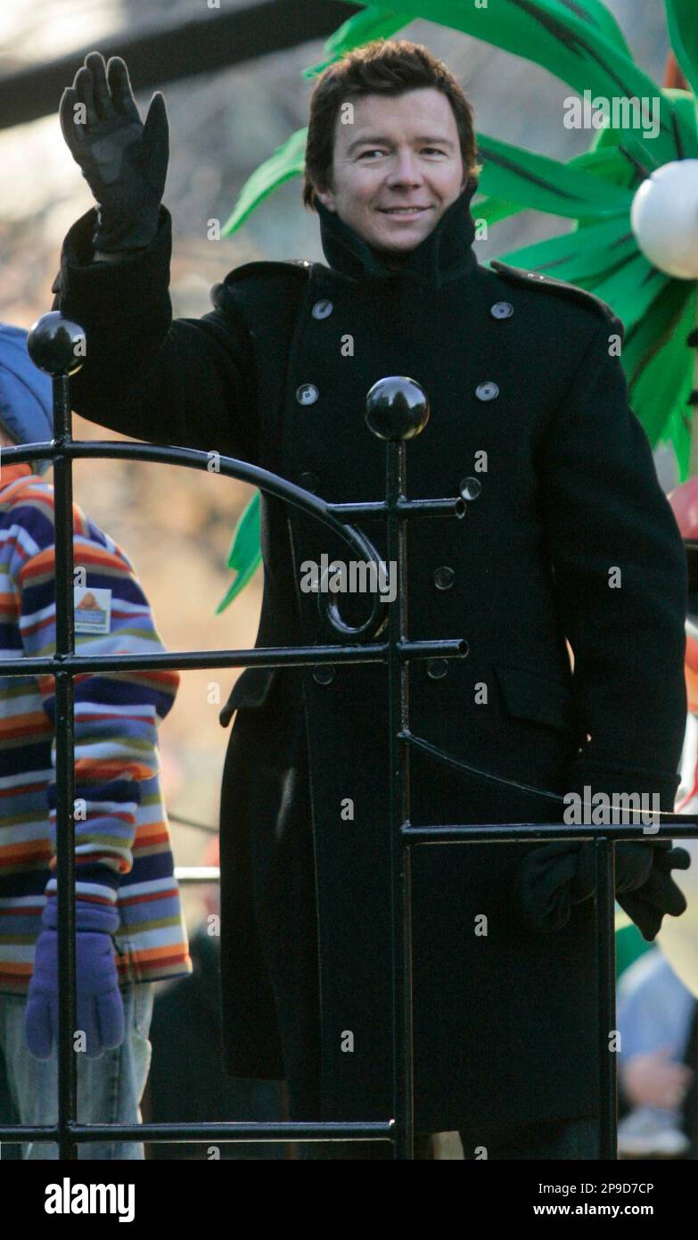 Musical Artist Rick Astley waves while riding on a float during the ...