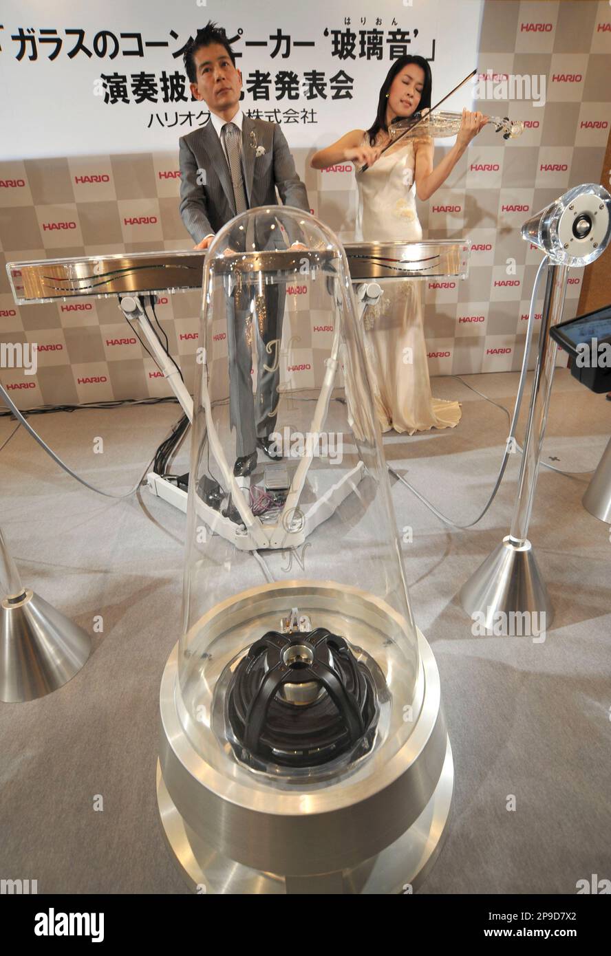 Japanese musicians, Ikuko Kawai, right, and Tomoyuki Asakawa play the glass-made violin and ...