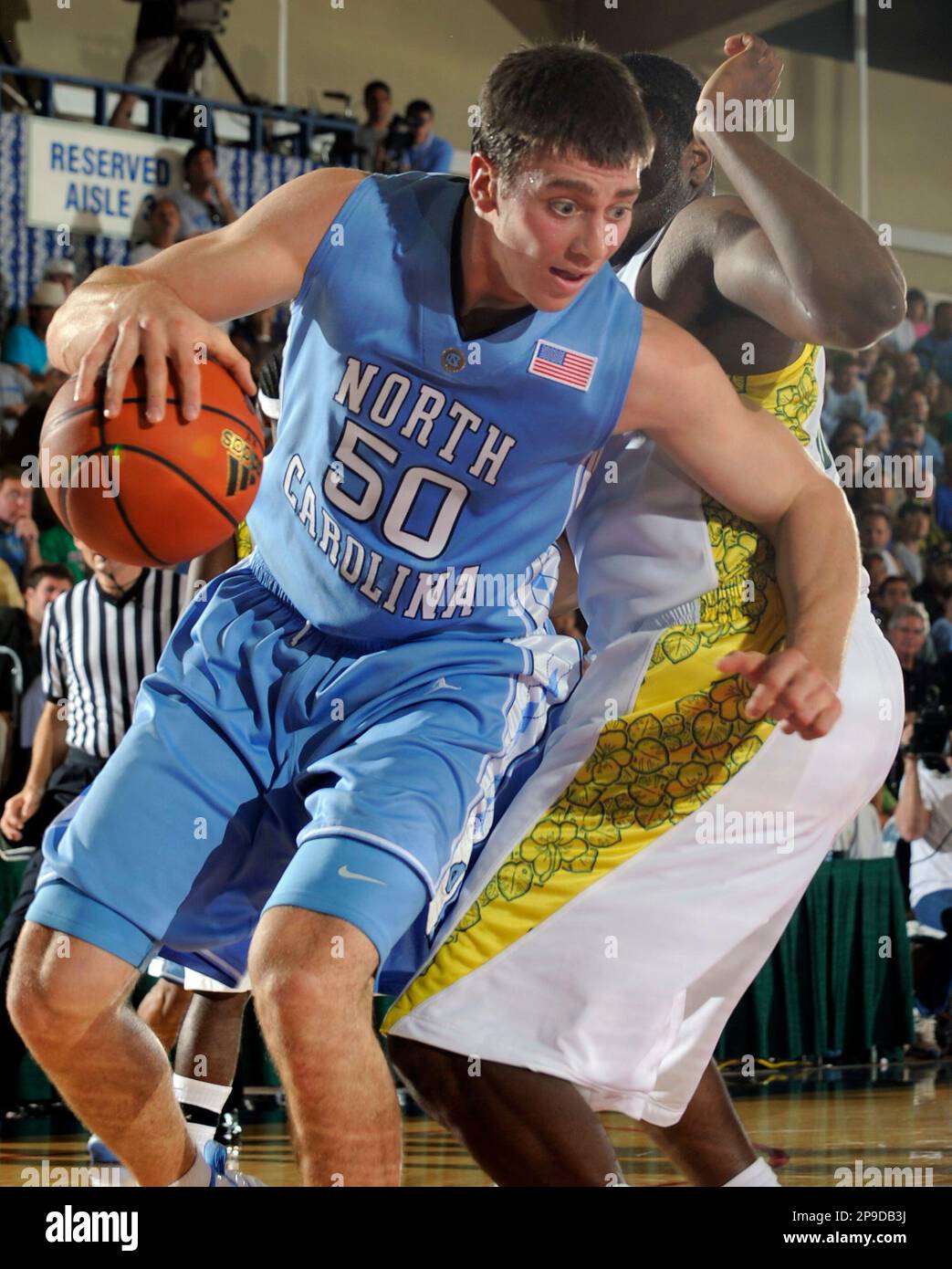 North Carolina's Tyler Hansbrough drives around Oregon's Joevan Catron ...