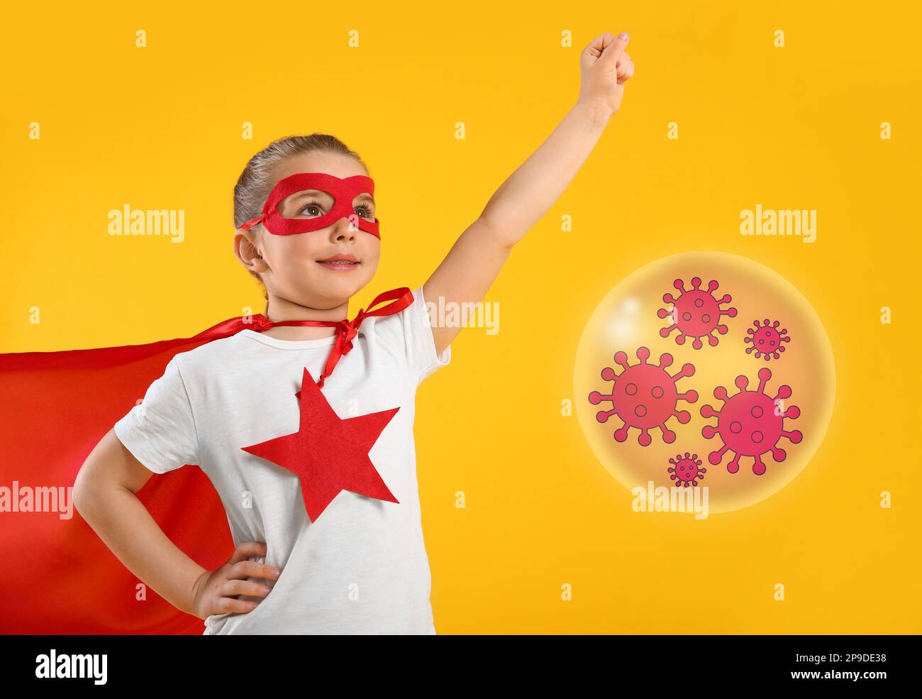 Little girl wearing superhero costume fighting against viruses on ...