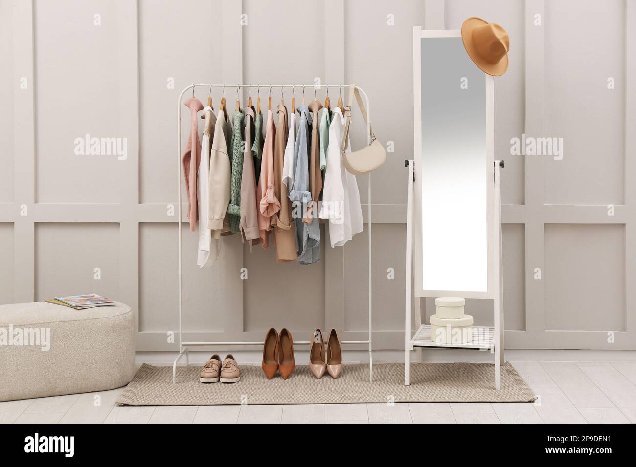 Rack with stylish women's clothes and mirror in dressing room Stock ...