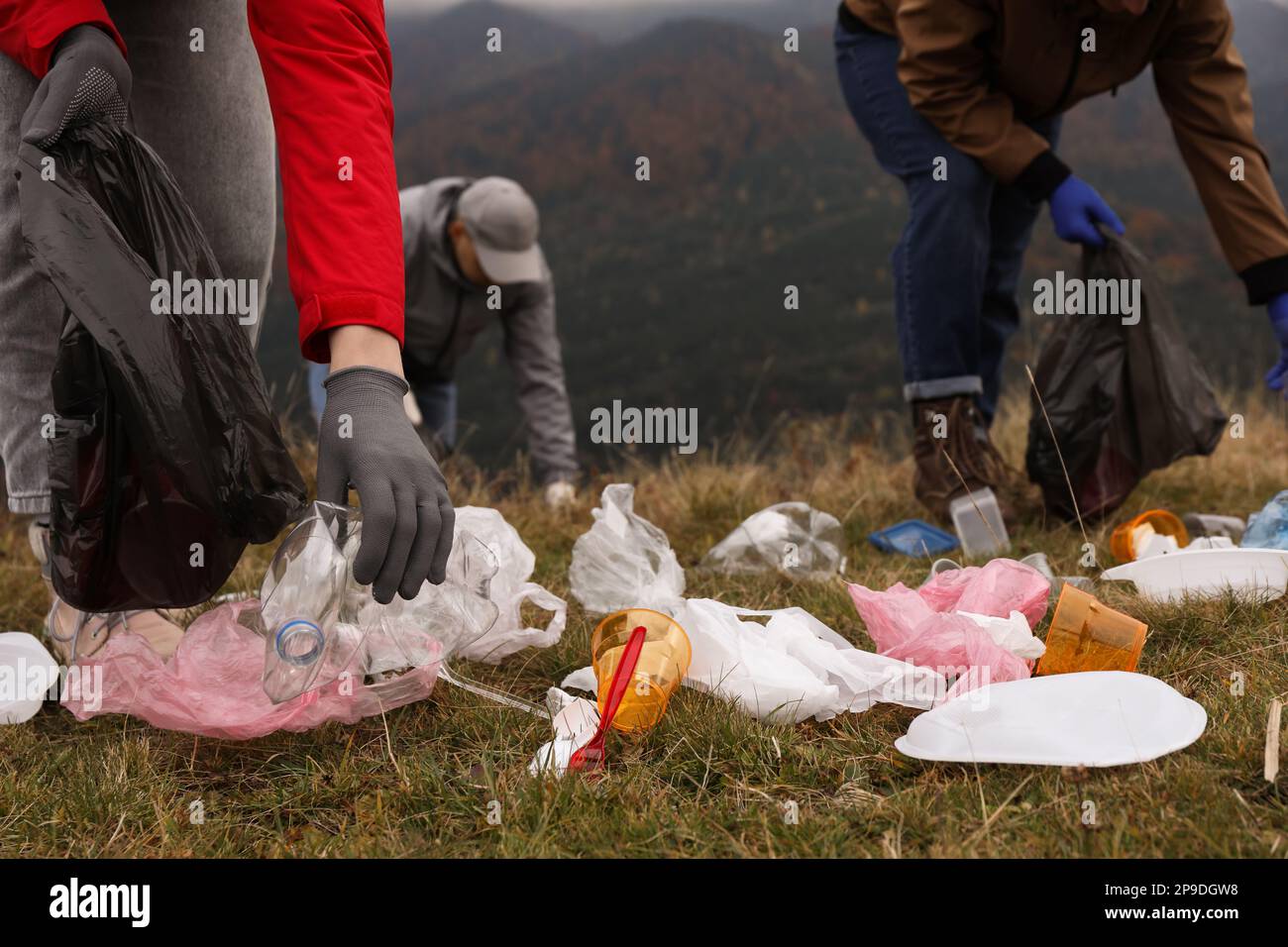 People with trash bags collecting garbage in nature, closeup Stock ...