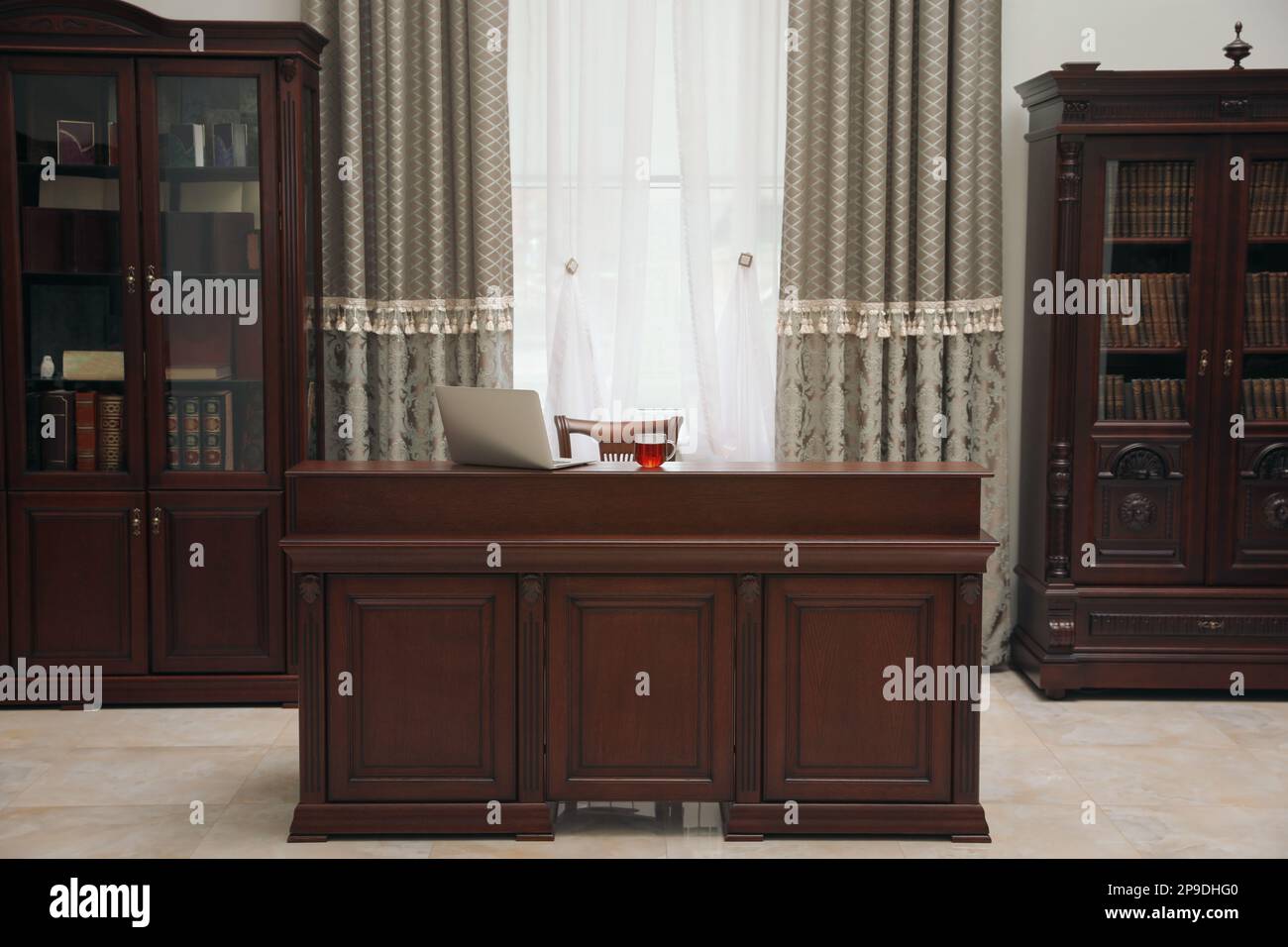 Library reading room interior with wooden bookcases and laptop on table ...