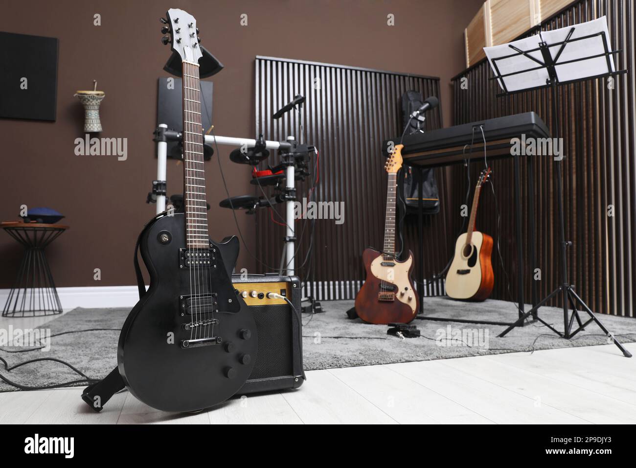 Electric guitar with amplifier at recording studio. Music band practice ...