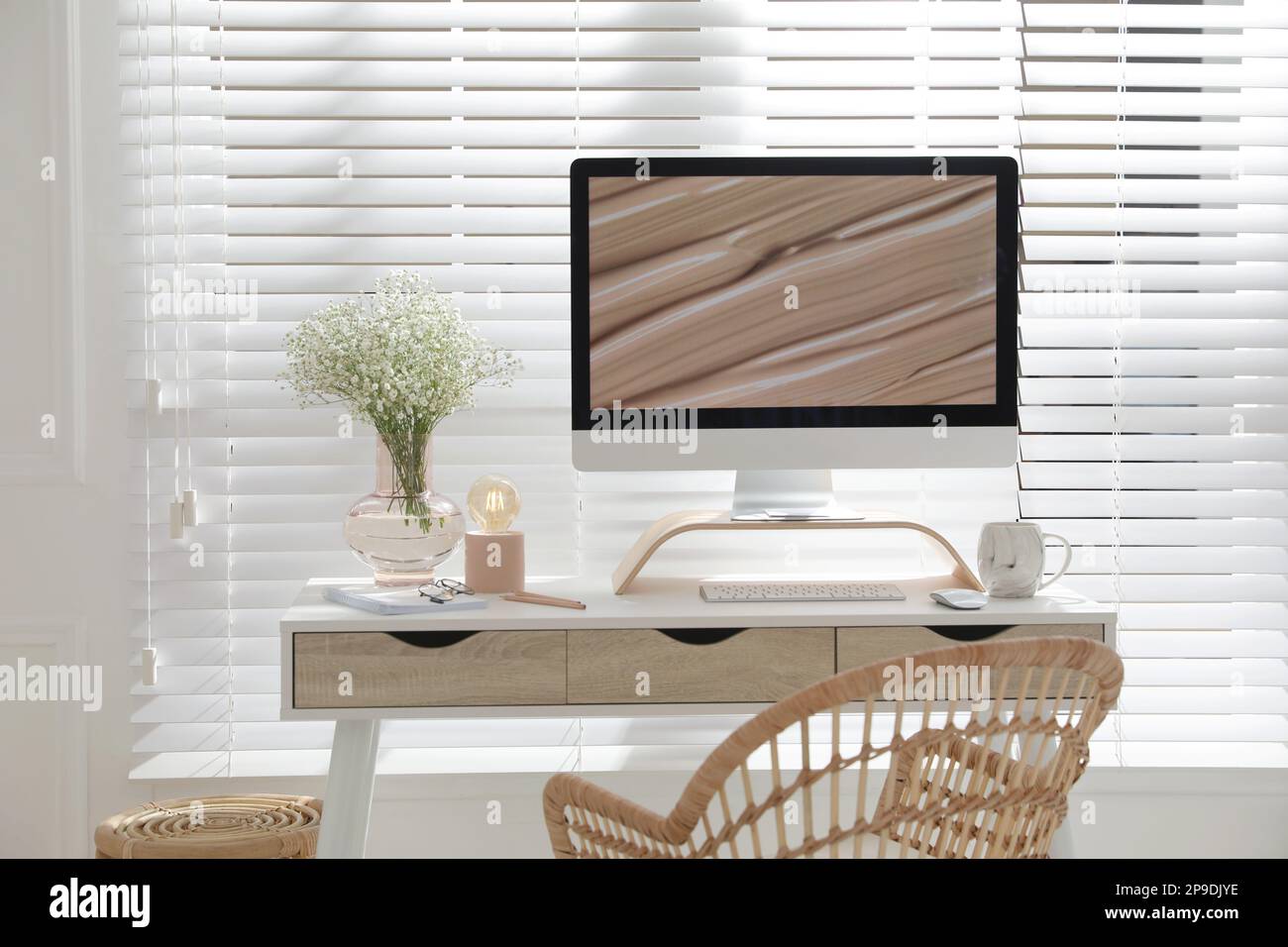 Comfortable workplace with modern computer and beautiful flowers in ...