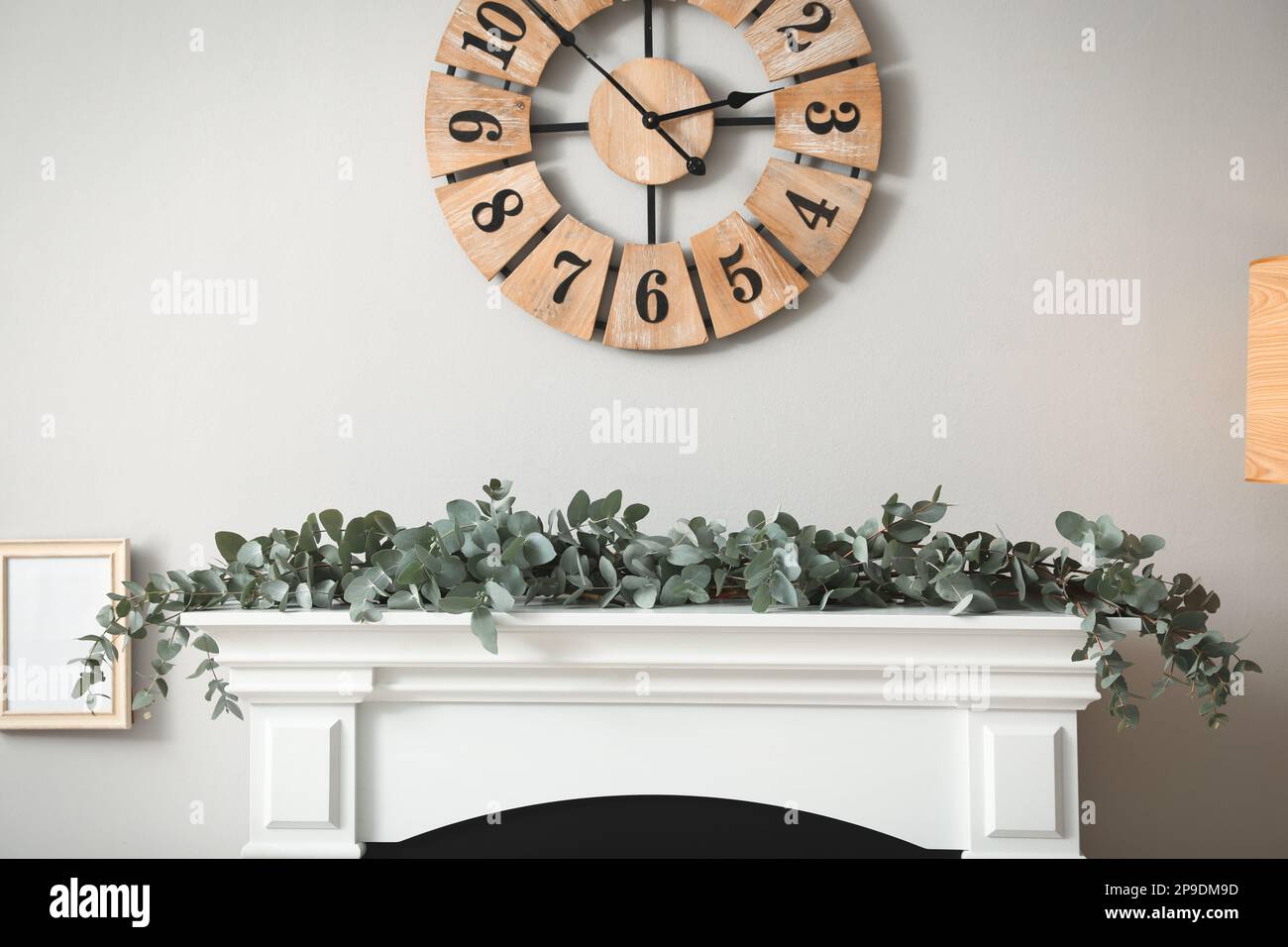 Beautiful garland with eucalyptus branches on mantelpiece in room Stock ...