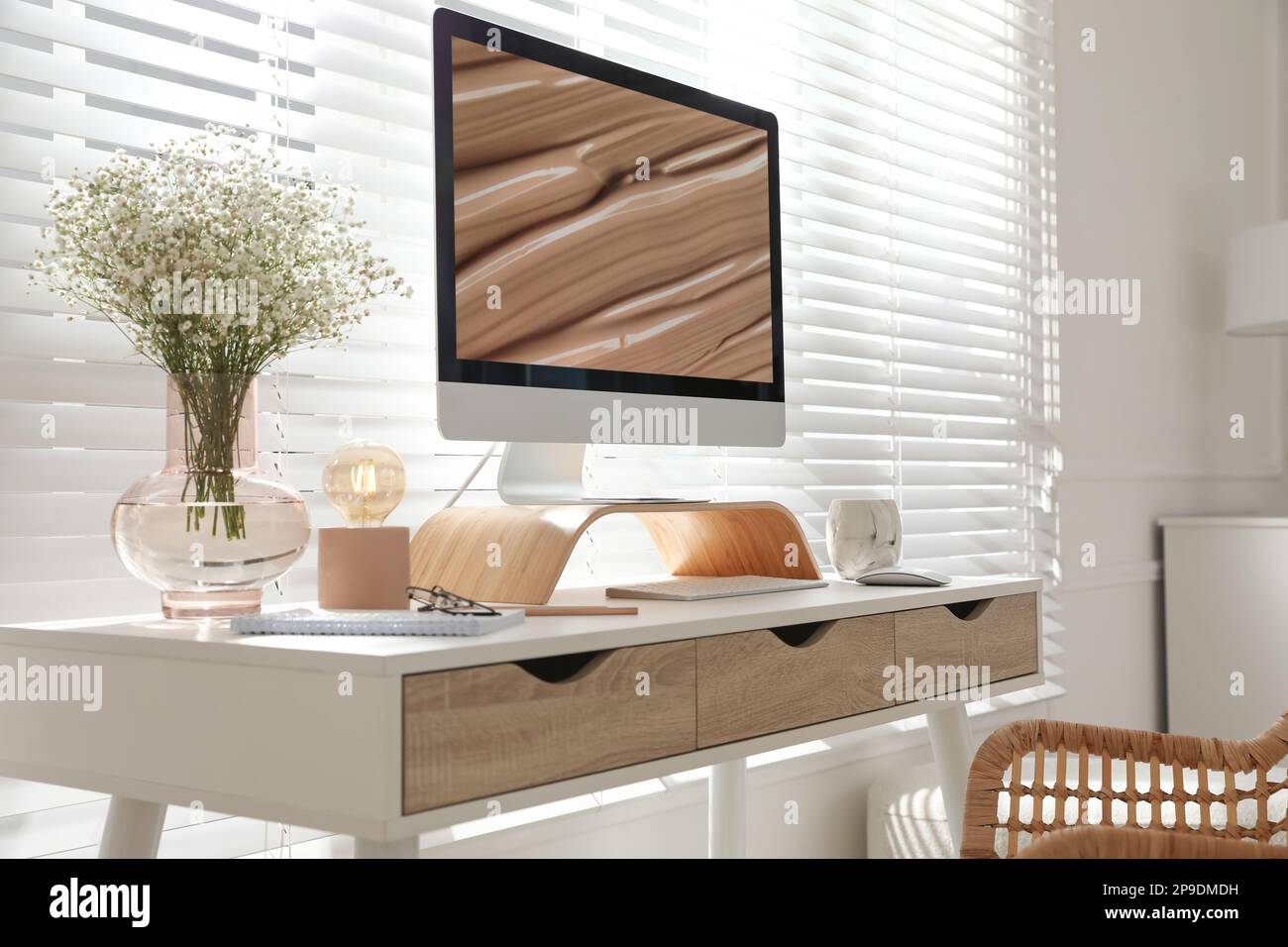 Comfortable workplace with modern computer and beautiful flowers in ...