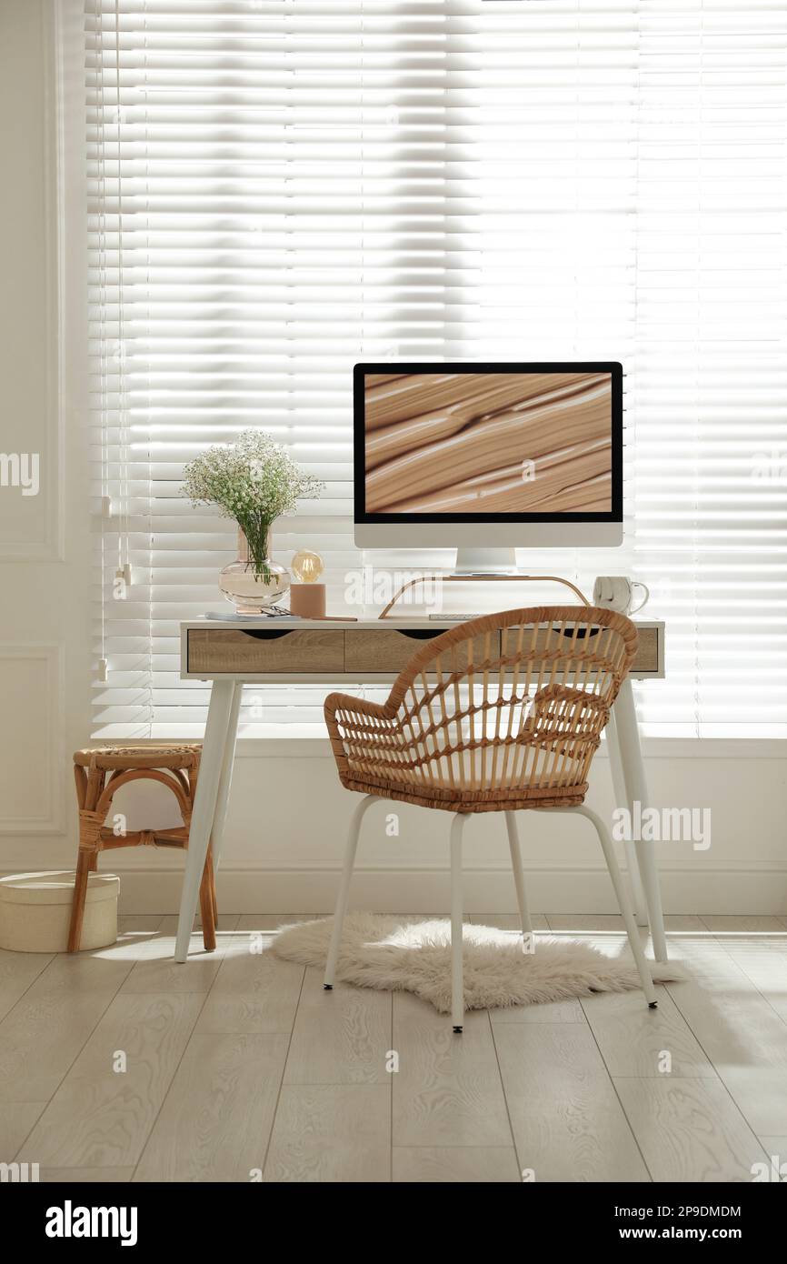 Comfortable workplace with modern computer and beautiful flowers in ...