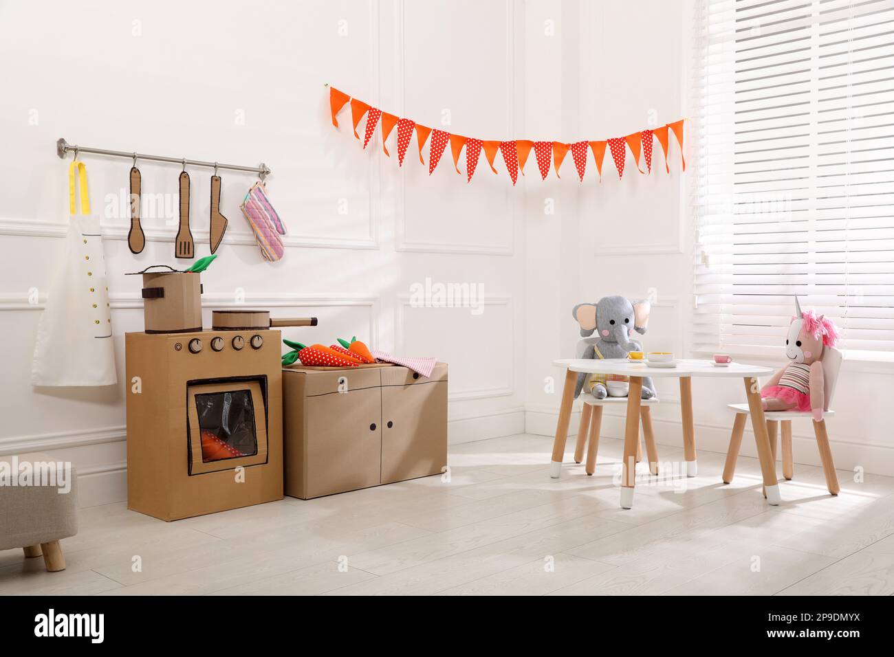 Toy cardboard kitchen with stove and utensils at home Stock Photo - Alamy