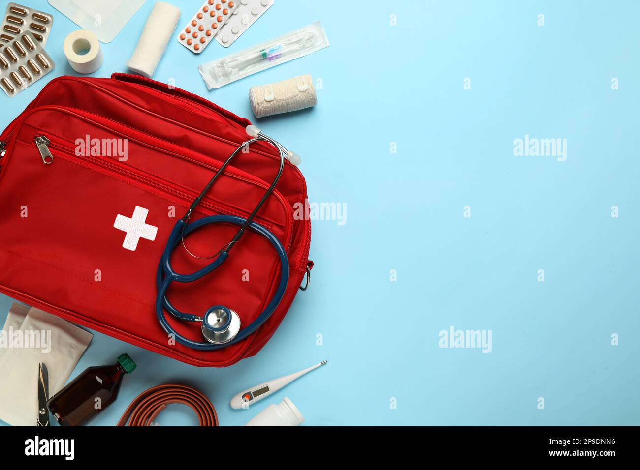 Flat lay composition with first aid kit on light blue background, space ...