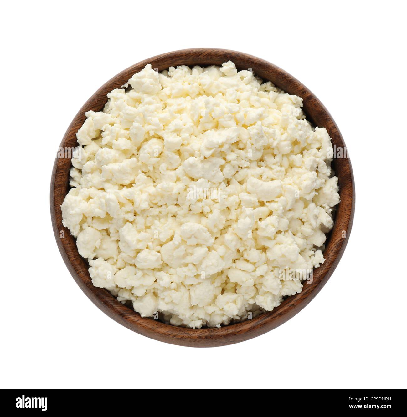 Delicious fresh cottage cheese in bowl isolated on white, top view ...