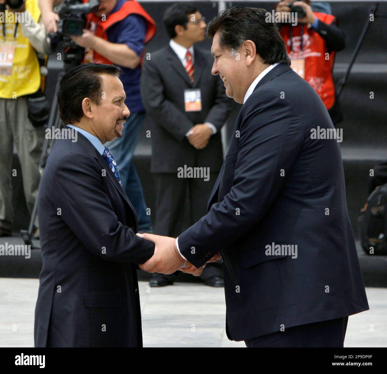 Brunei's Sultan Haji Hassanal Bolkiah, left, is greeted by Peru's ...