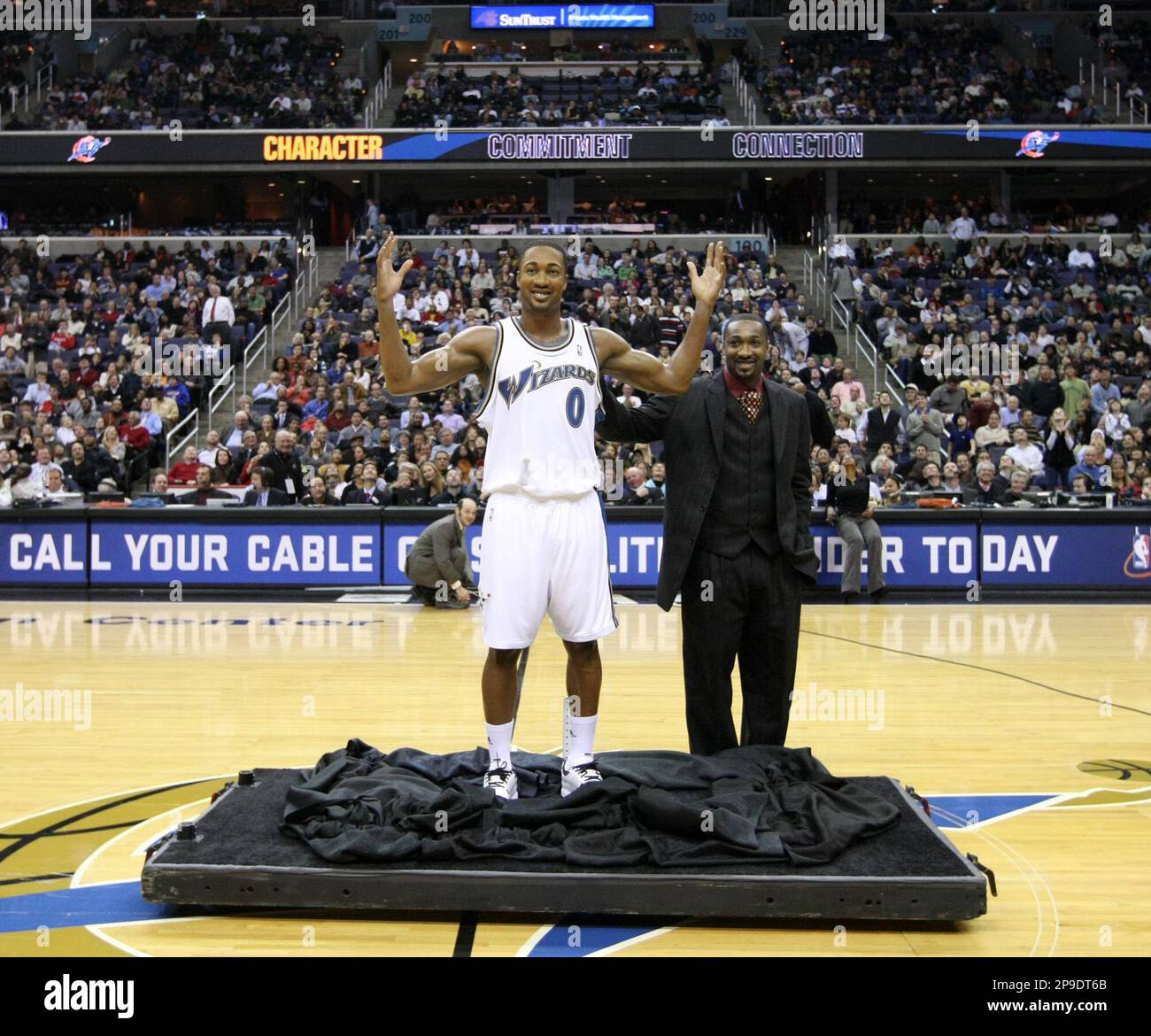 Washington Wizards’ Gilbert Arenas, right, poses next to a wax statue ...