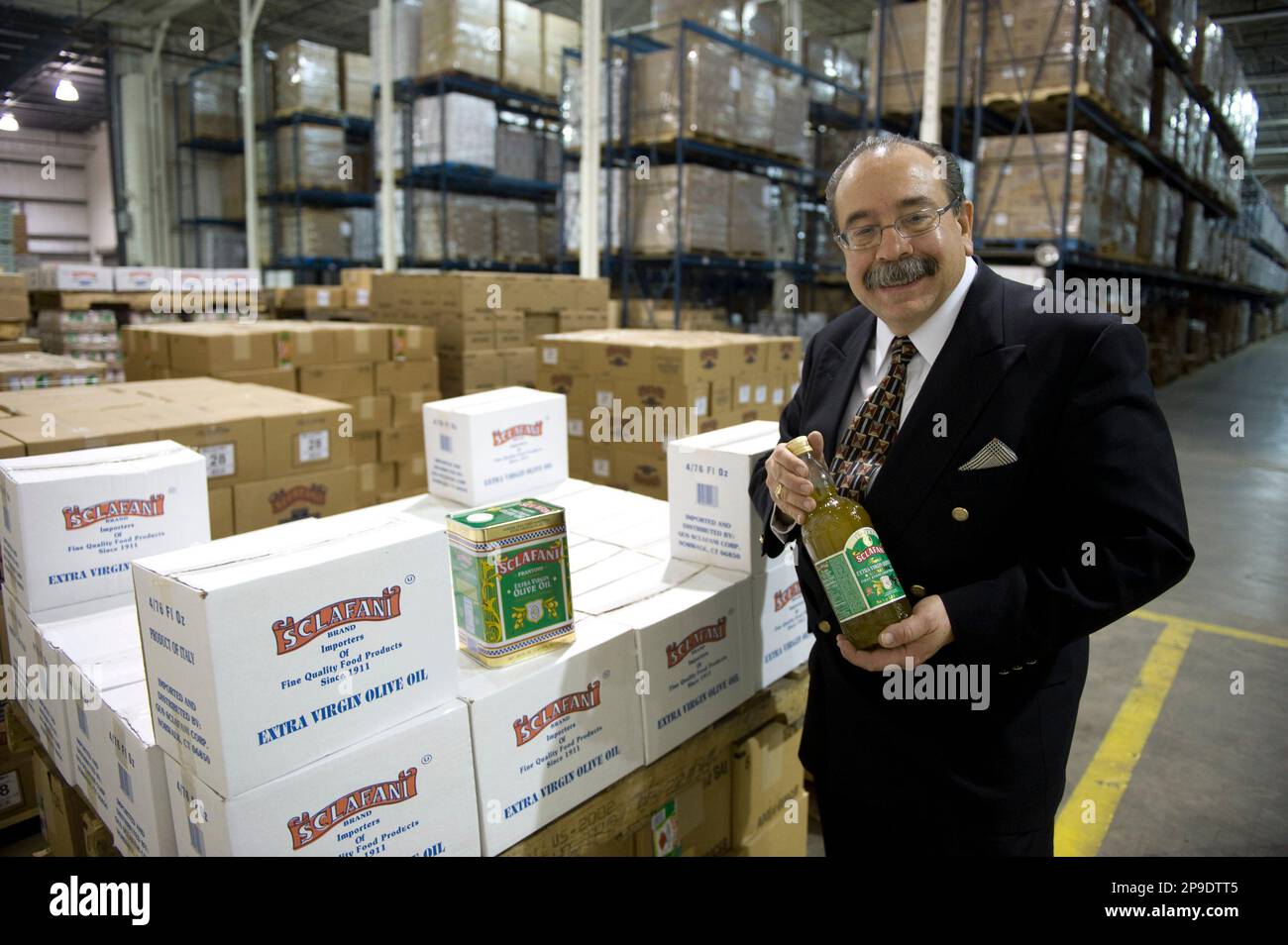Luciano Sclafani shows some of the extra virgin olive oil that he sells ...