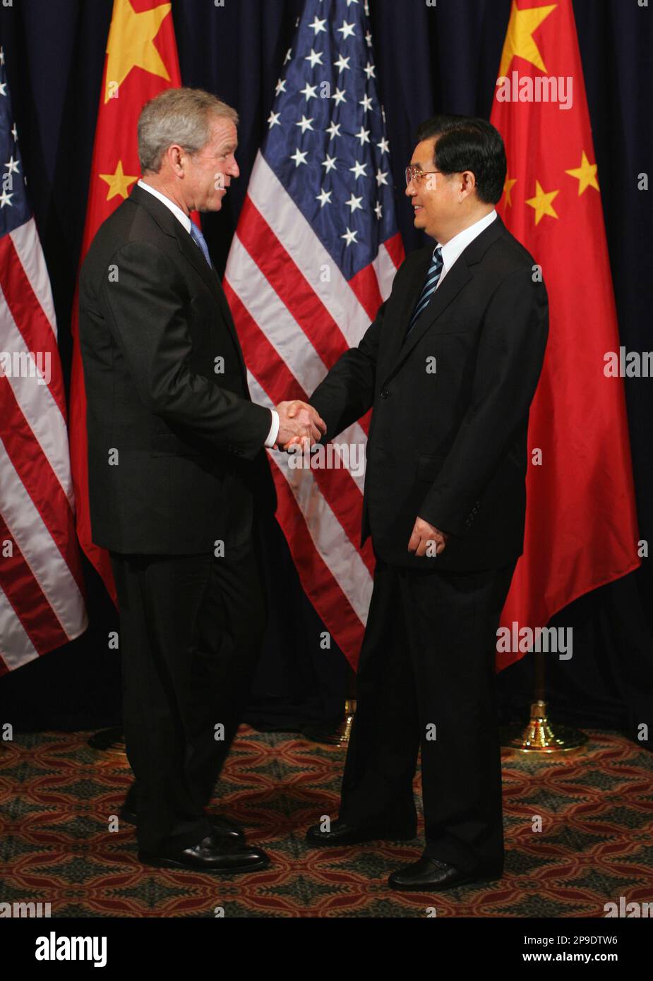 U.S. President George W. Bush, left, greets President Hu Jintao of ...