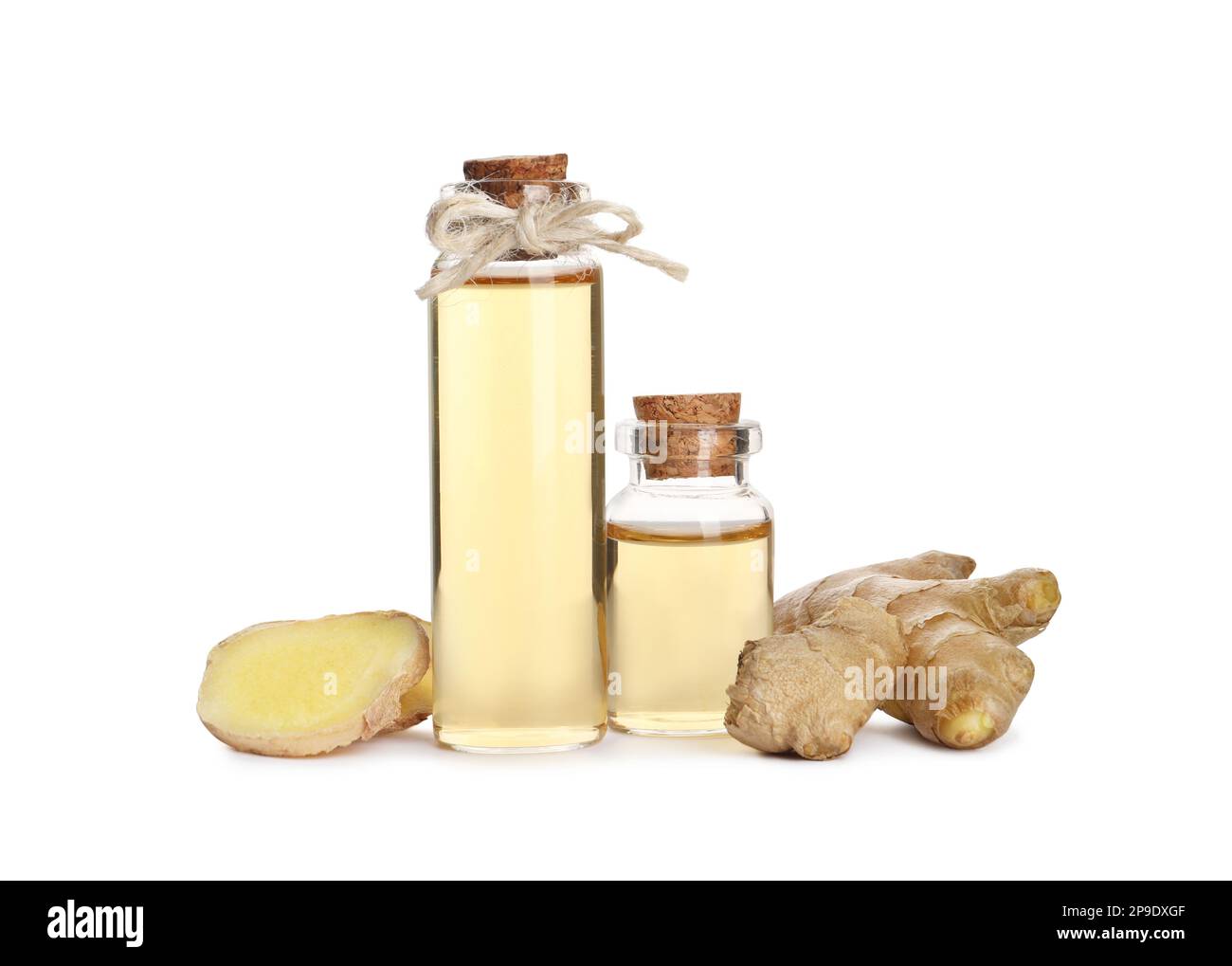 Glass bottles of essential oil and ginger root on white background ...