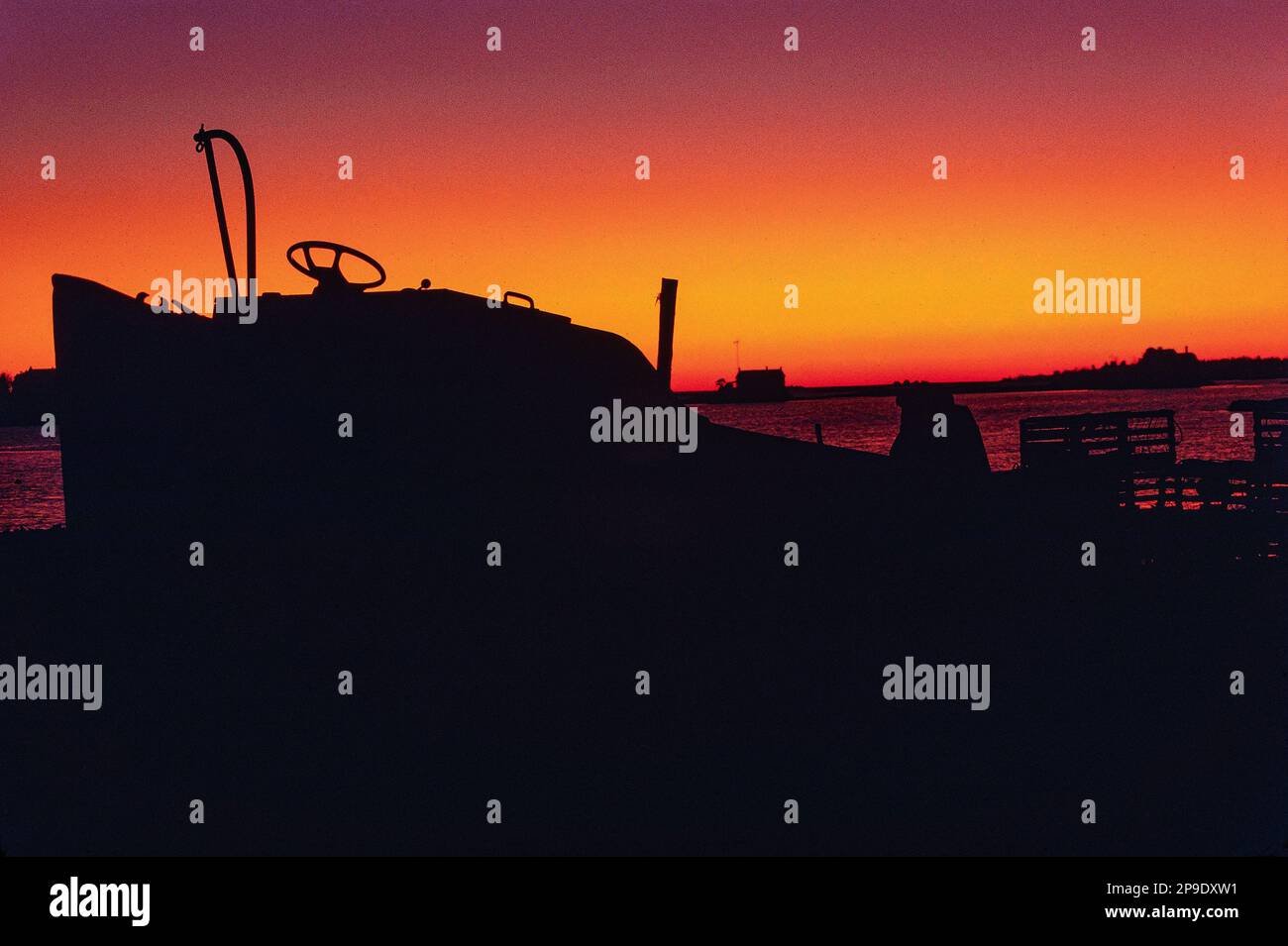 Small lobster boat beached in Stony Creek harbor at sunset with Thimble ...