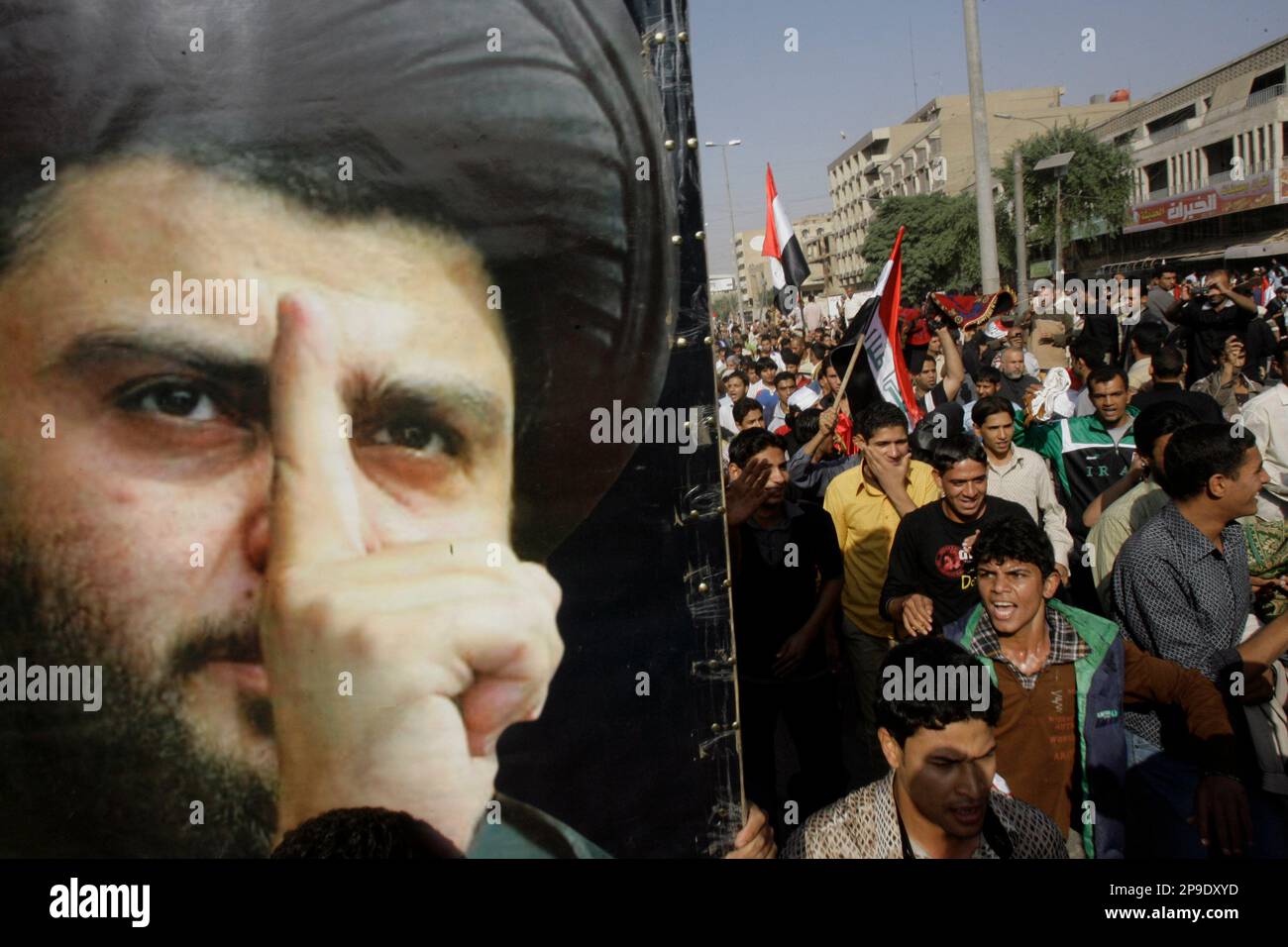 Thousands of followers of Shiite cleric Muqtada al-Sadr, pictured in ...