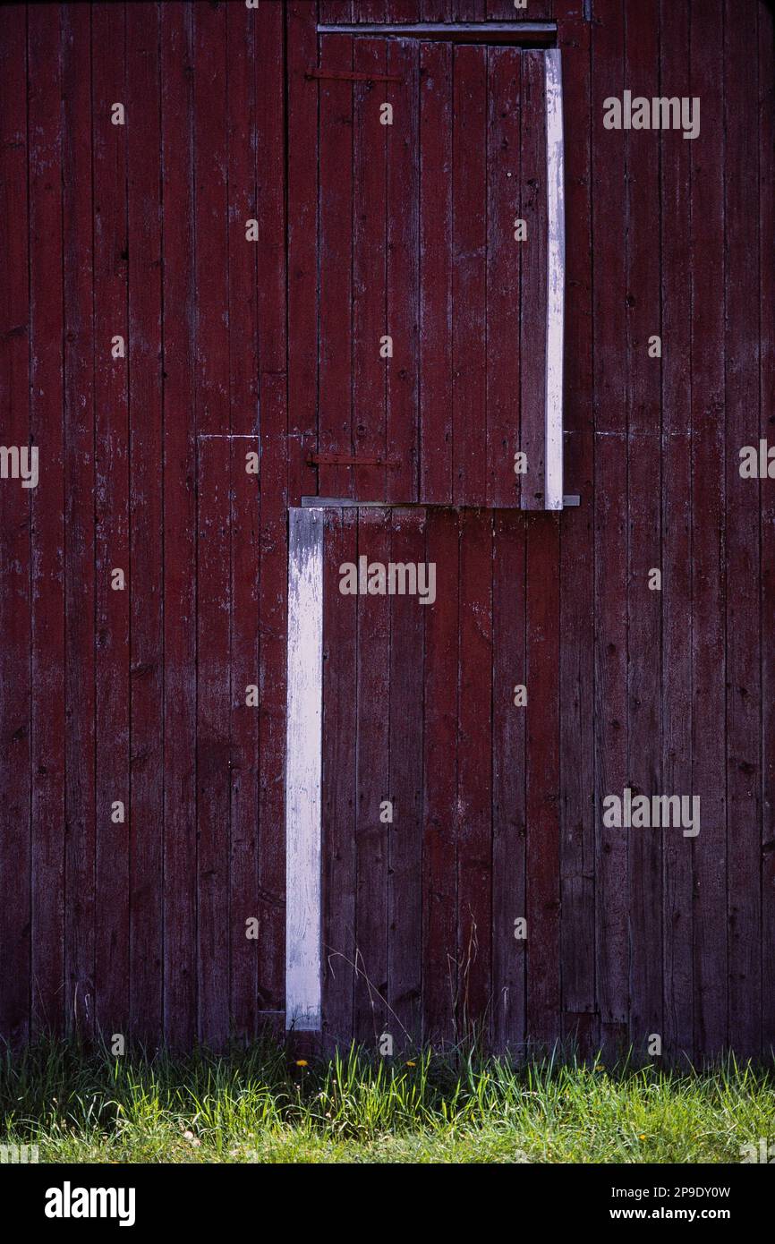 red barn boards set off with white trim create a zigzag pattern on the ...