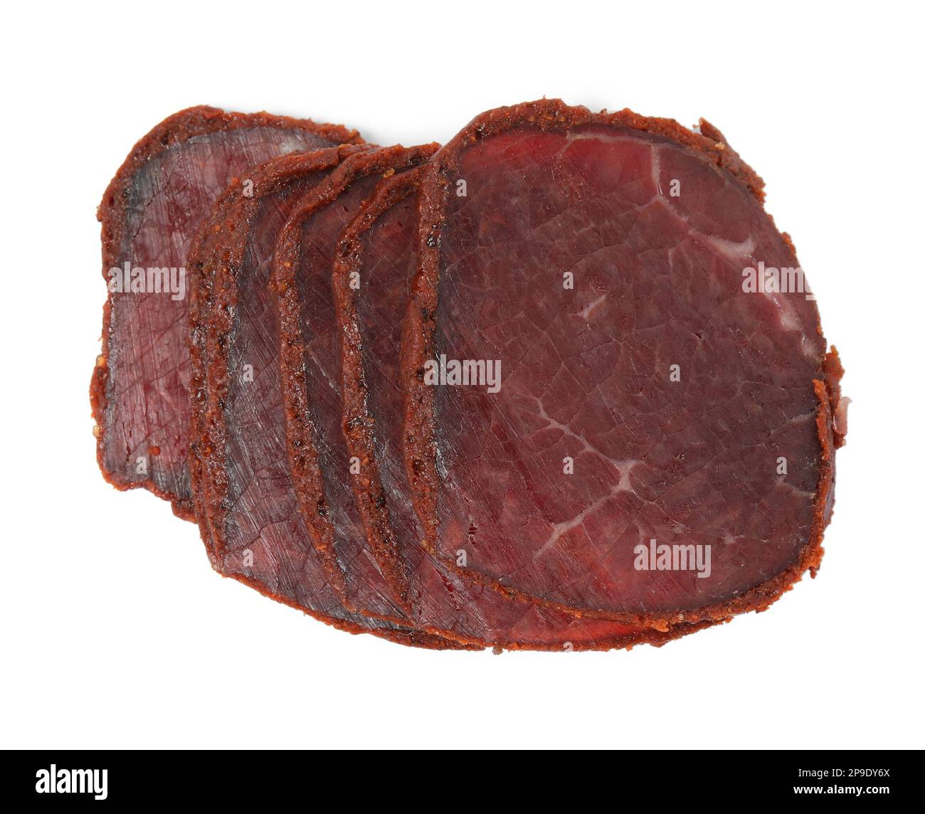 Delicious dry-cured beef basturma slices on white background, top view ...