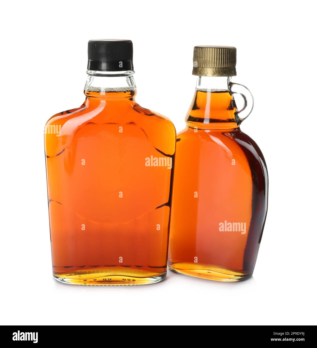 Bottles of tasty maple syrup on white background Stock Photo - Alamy